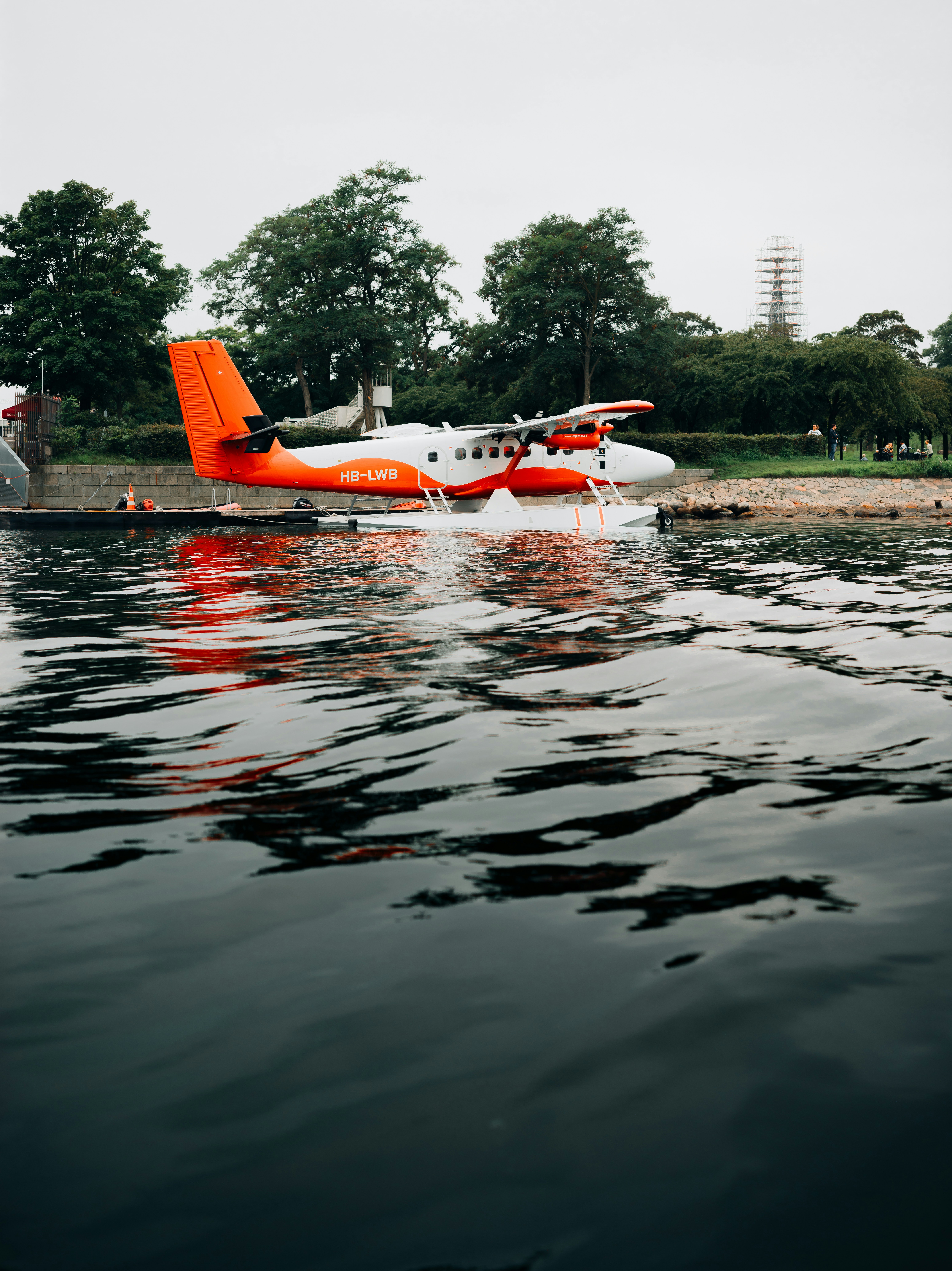 Harbor Quiet: Orange Seaplane on a Jetty