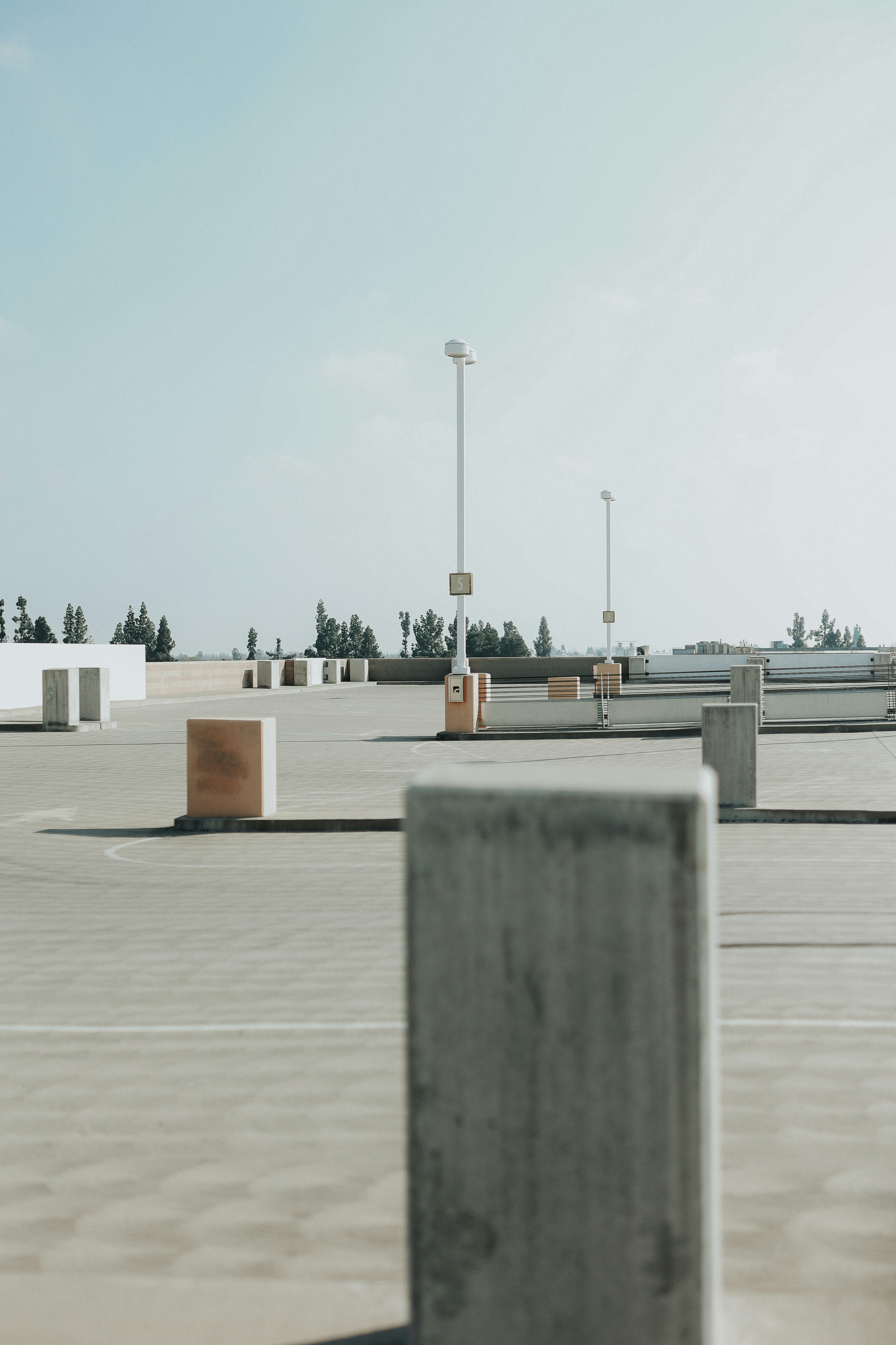Rooftop Geometry: Concrete Bollards Align Toward a Quiet Sky