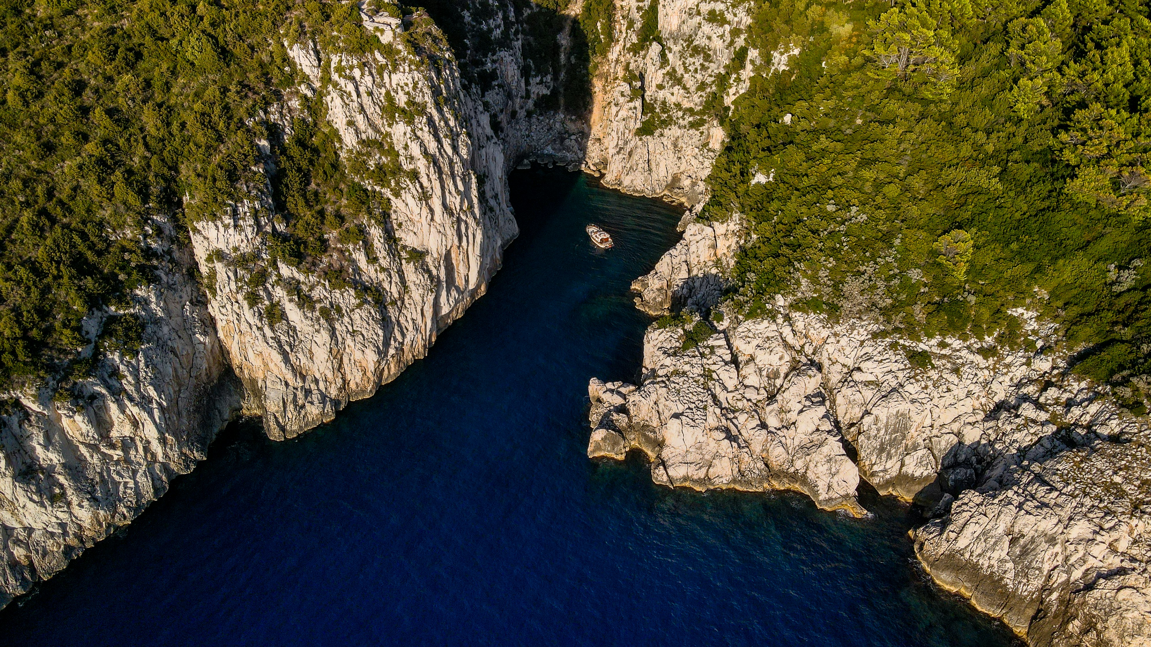 An aerial view of a body of water between two cliffs photo – Free Italy ...
