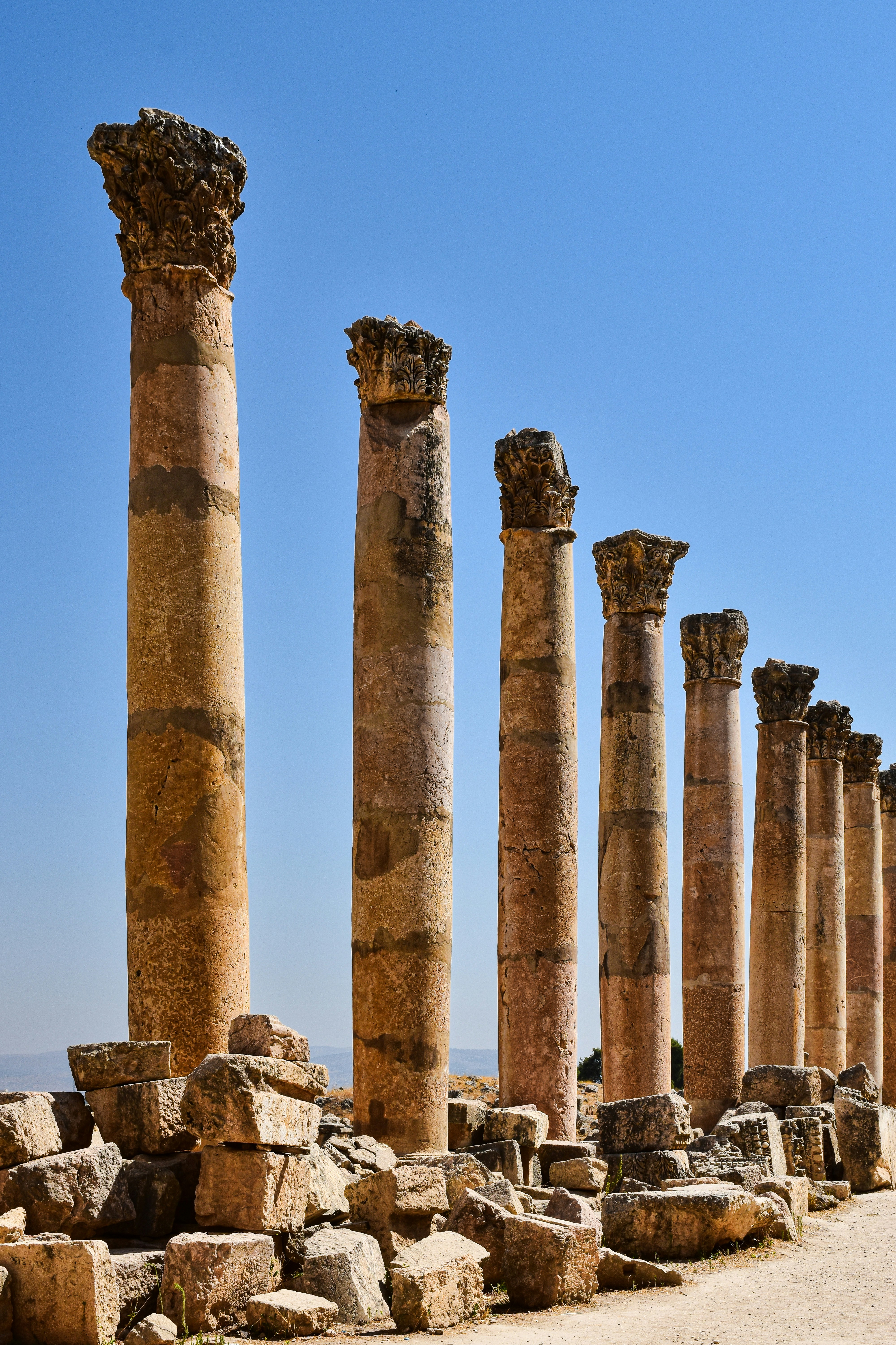A row of stone pillars sitting next to each other photo – Free Jordan ...