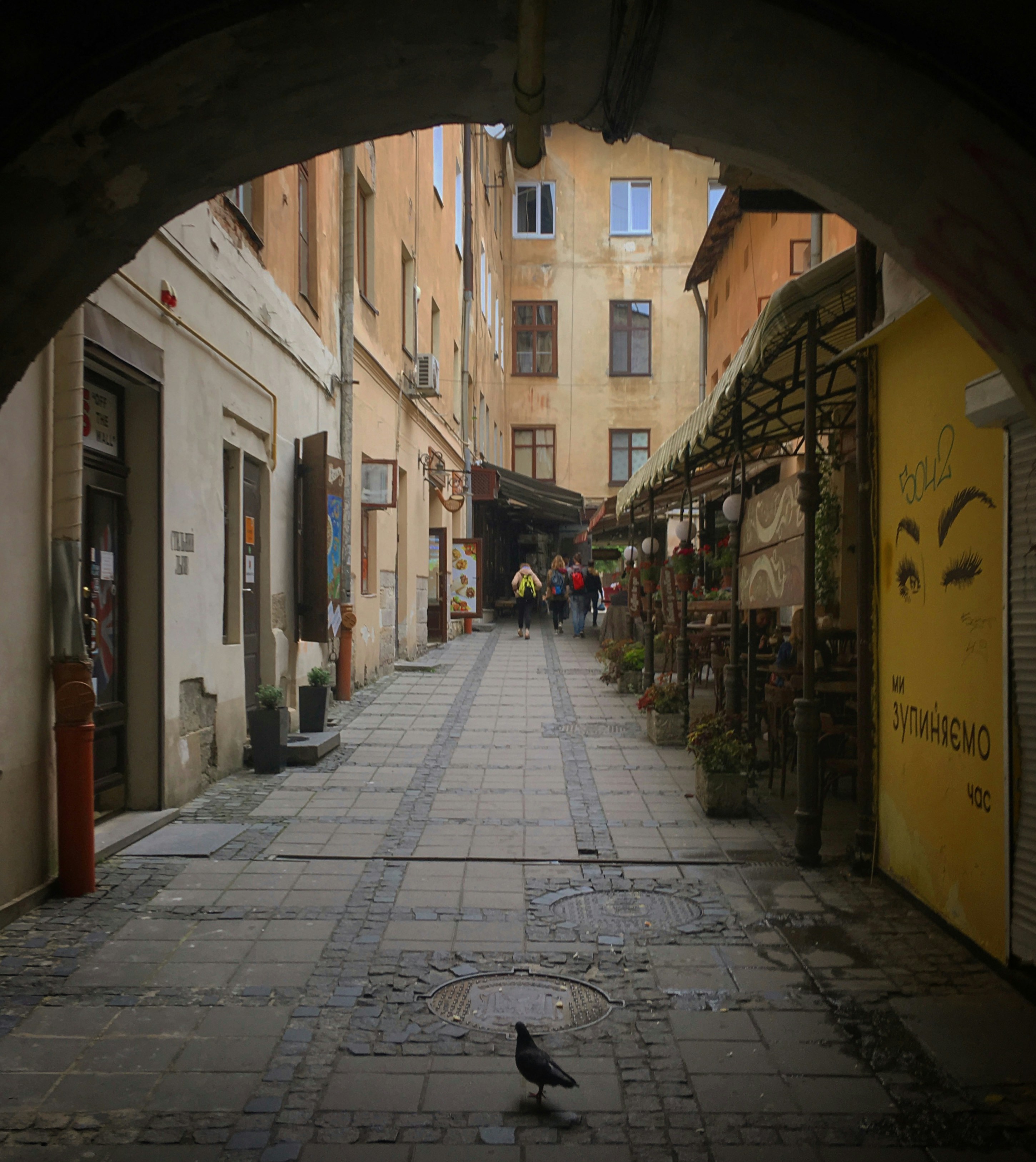 Archway Path: Narrow Street Toward Aged Buildings and Market