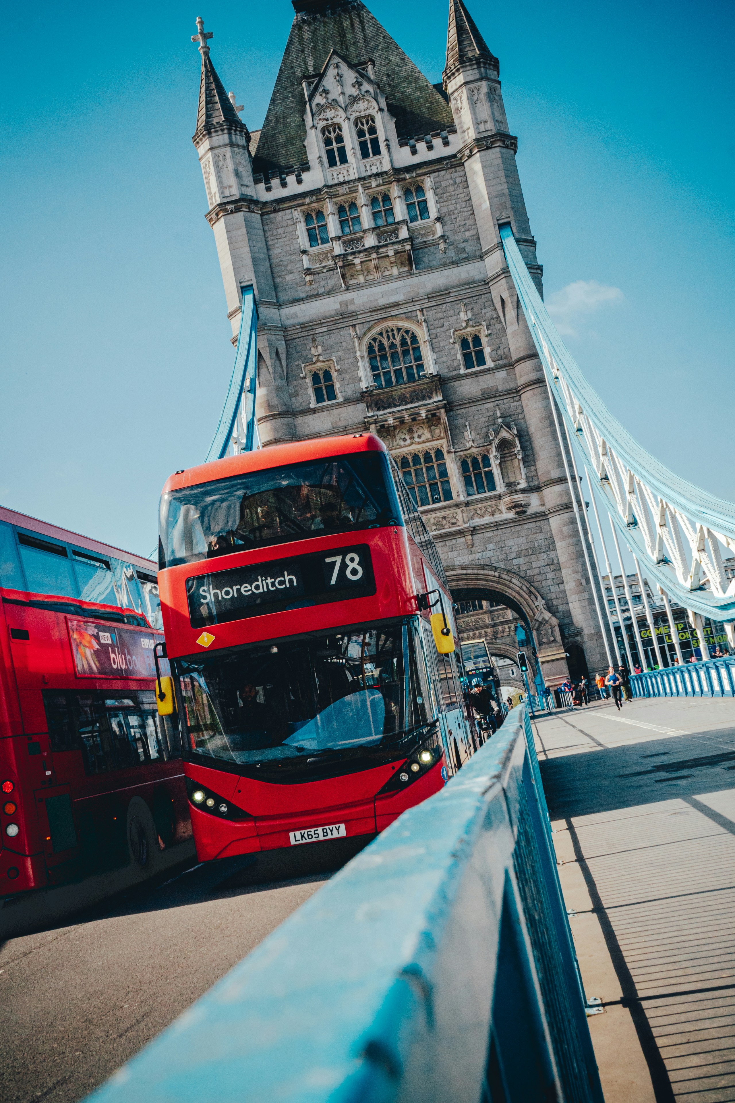 A red double decker bus driving over a bridge photo – Free London Image ...