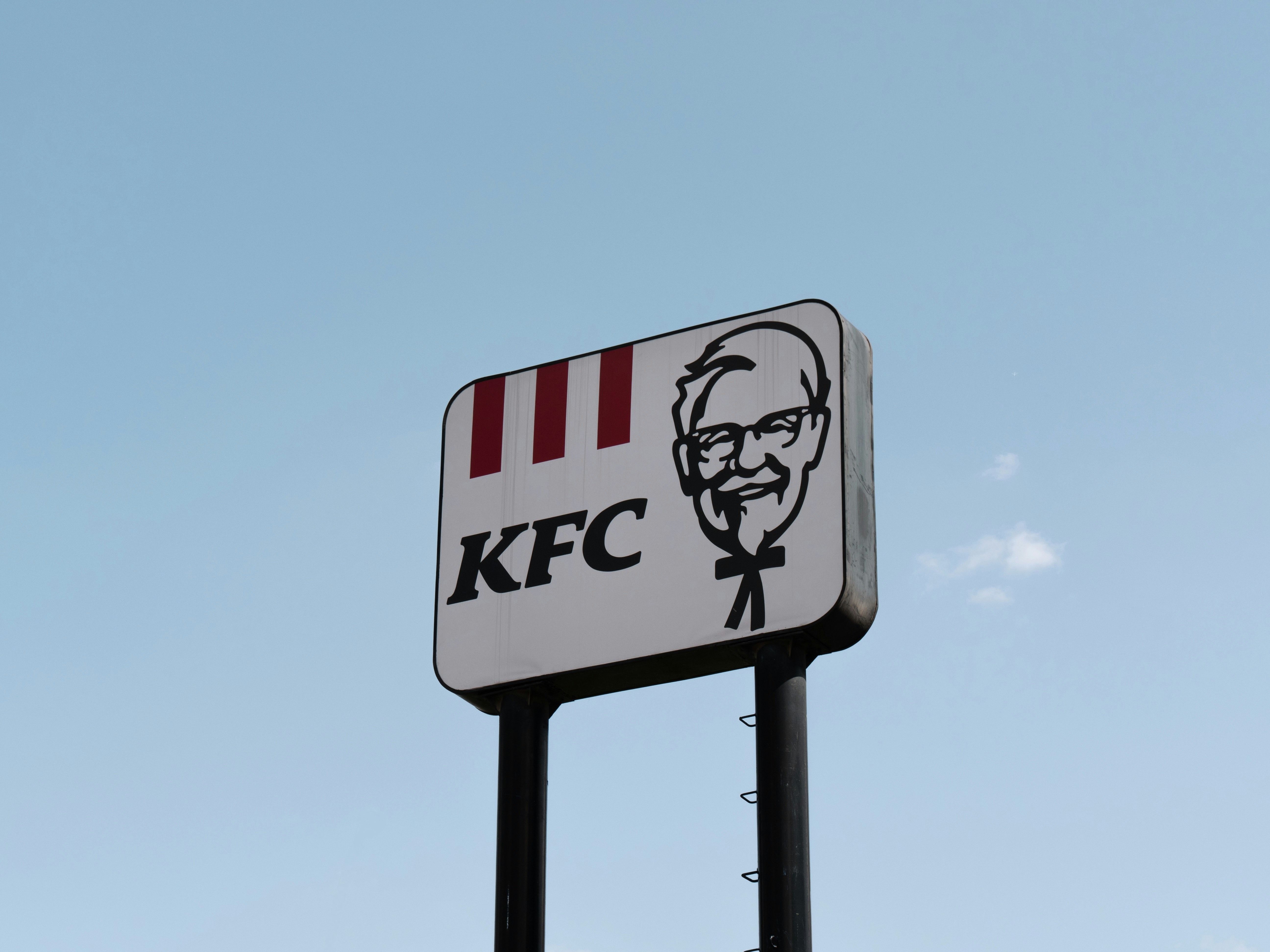A kfc sign with a picture of a man on it photo – Free Sign Image on ...