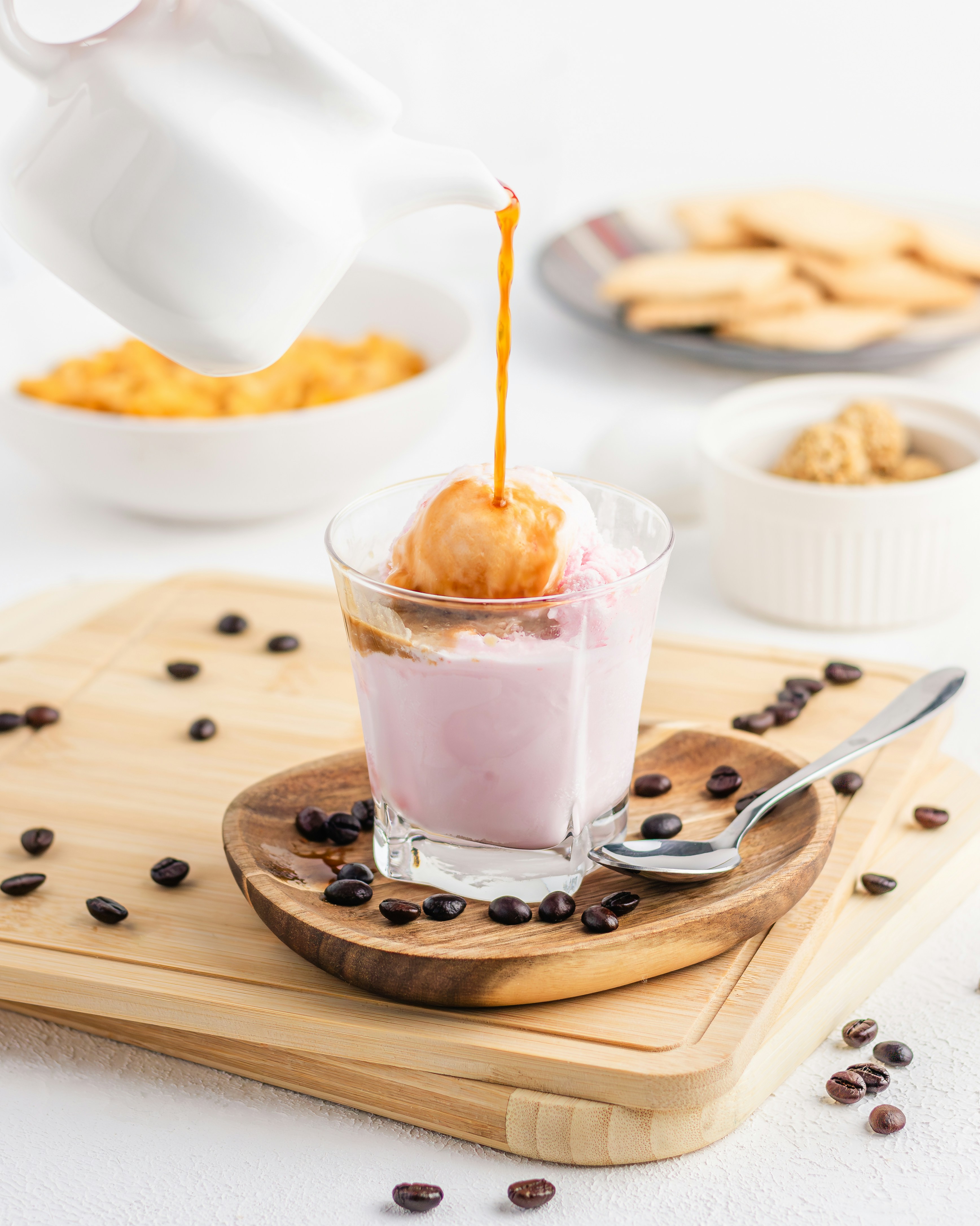 Ice cream float with caramel drizzle over berry yogurt in a cafe setting