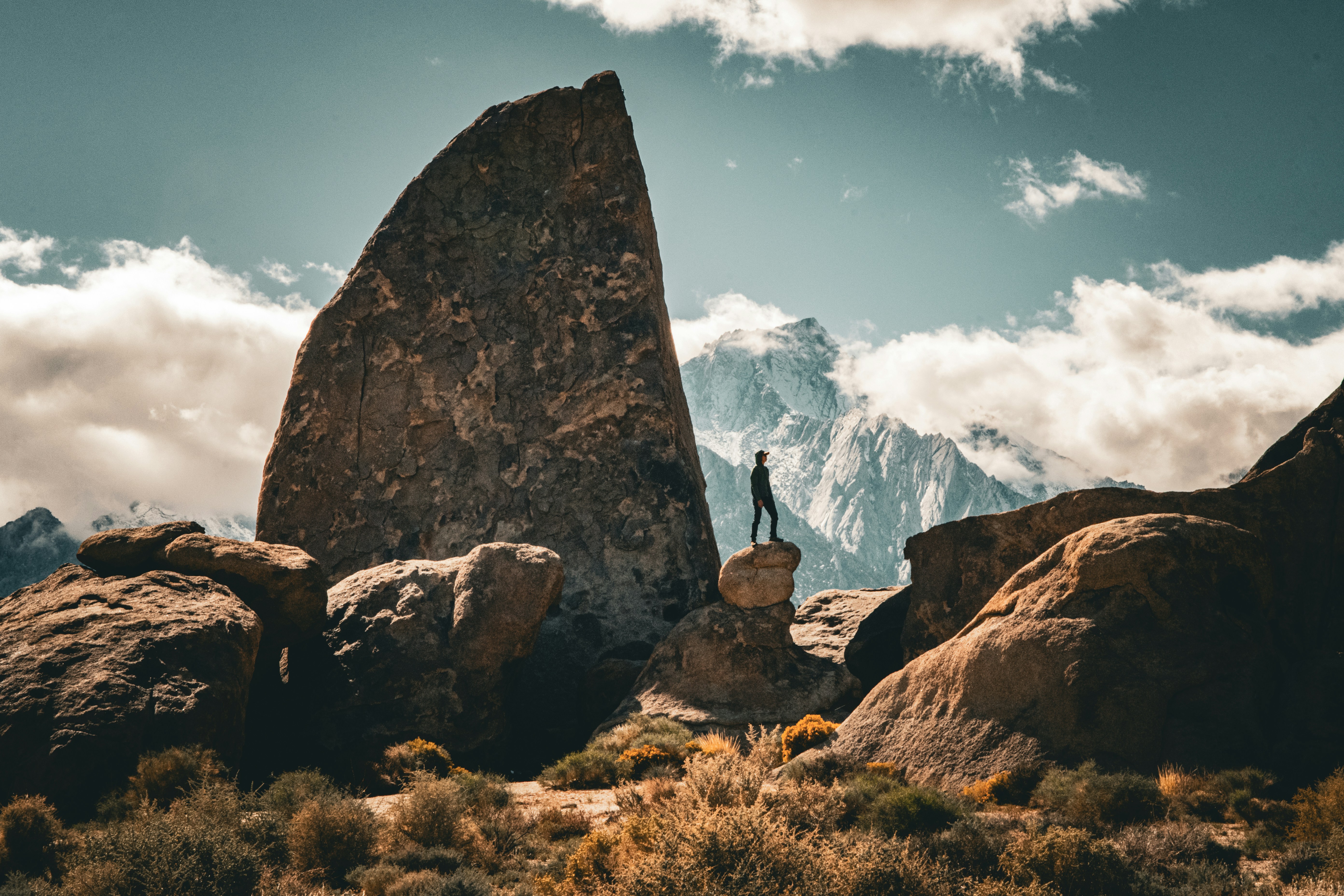 Figure on the Granite Sentinel Under a Rugged Sky