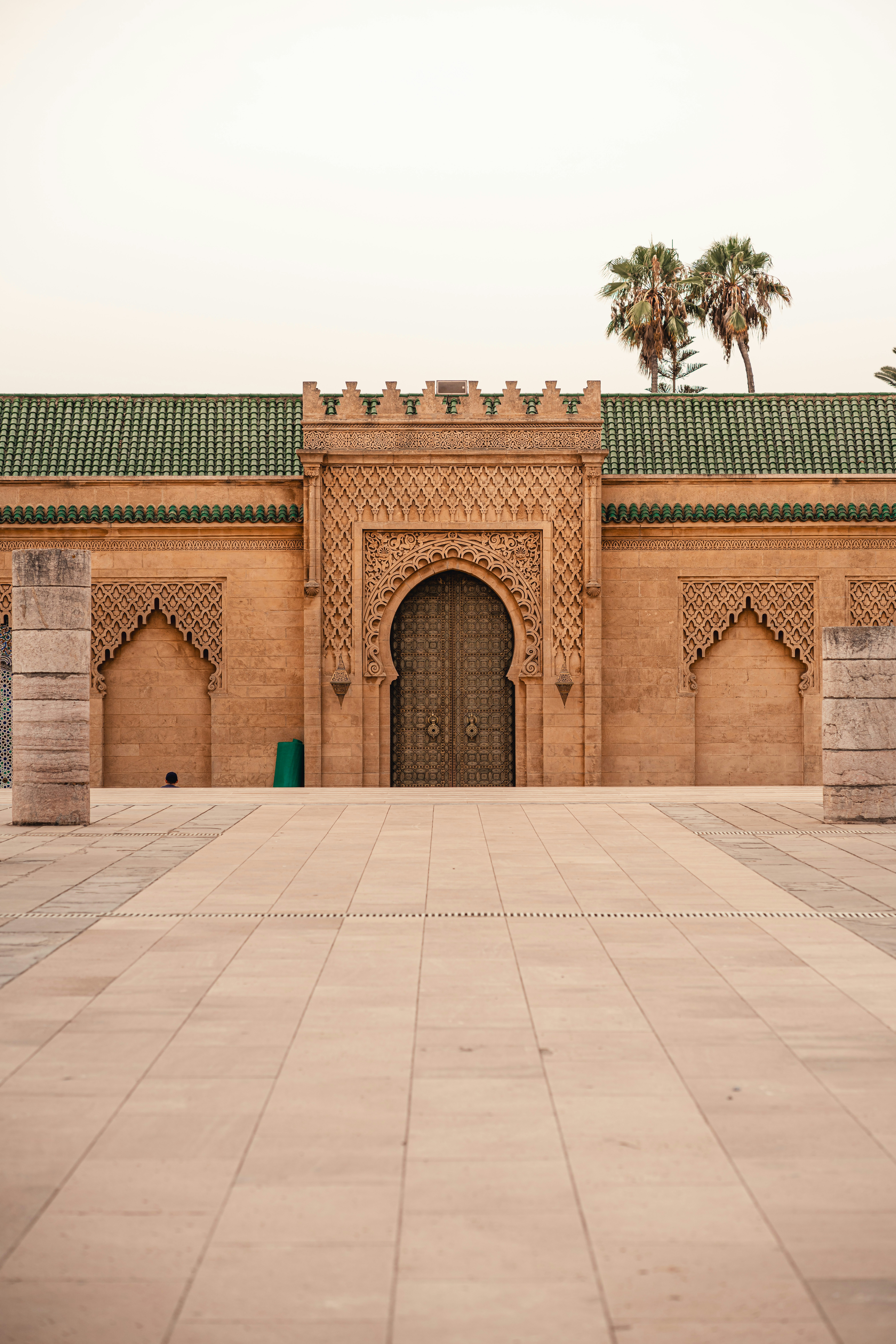 Carved Moorish Gate: Sunlit Portal in a Desert Courtyard