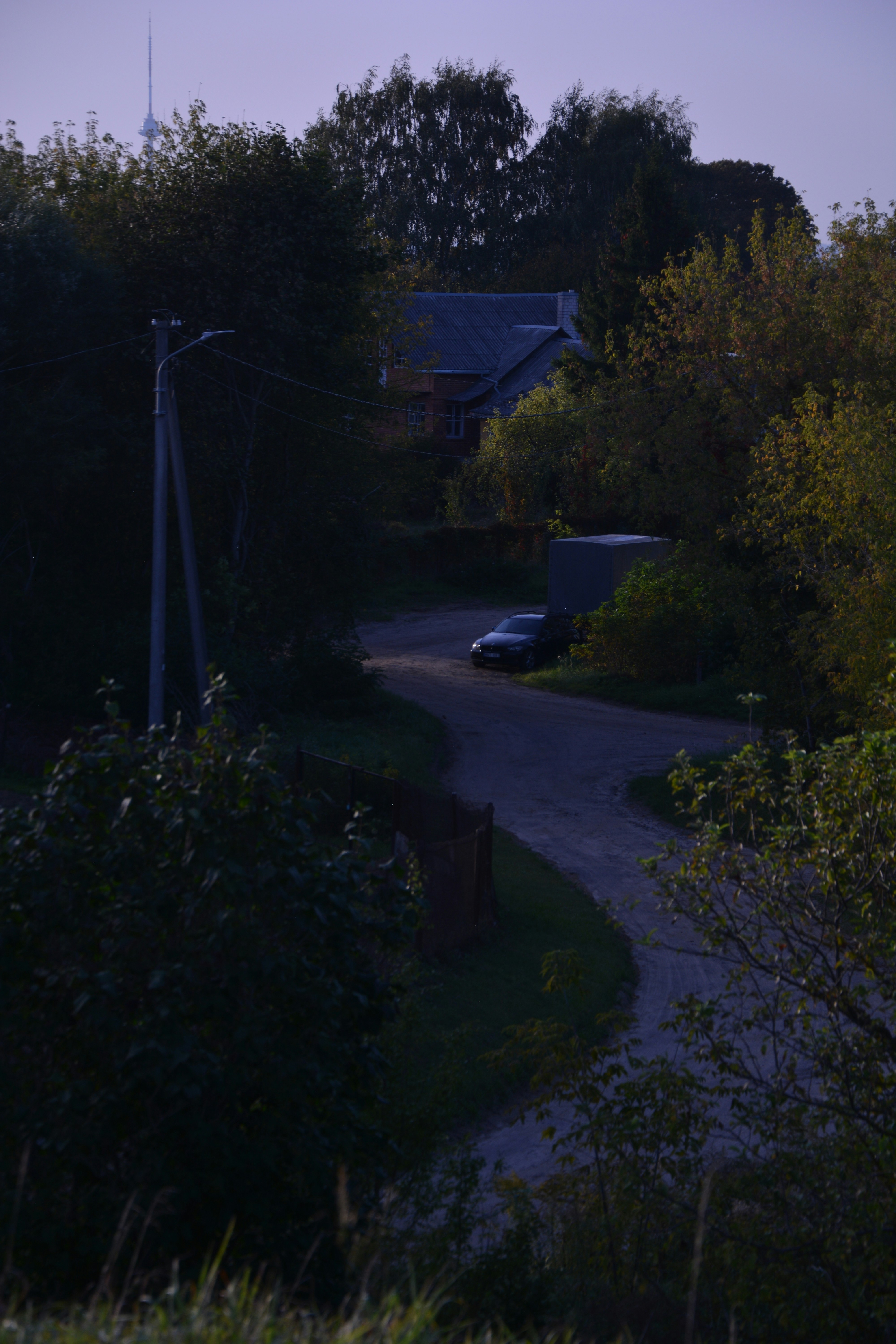 Twilight Curve: A Quiet Backroad with a Parked Car