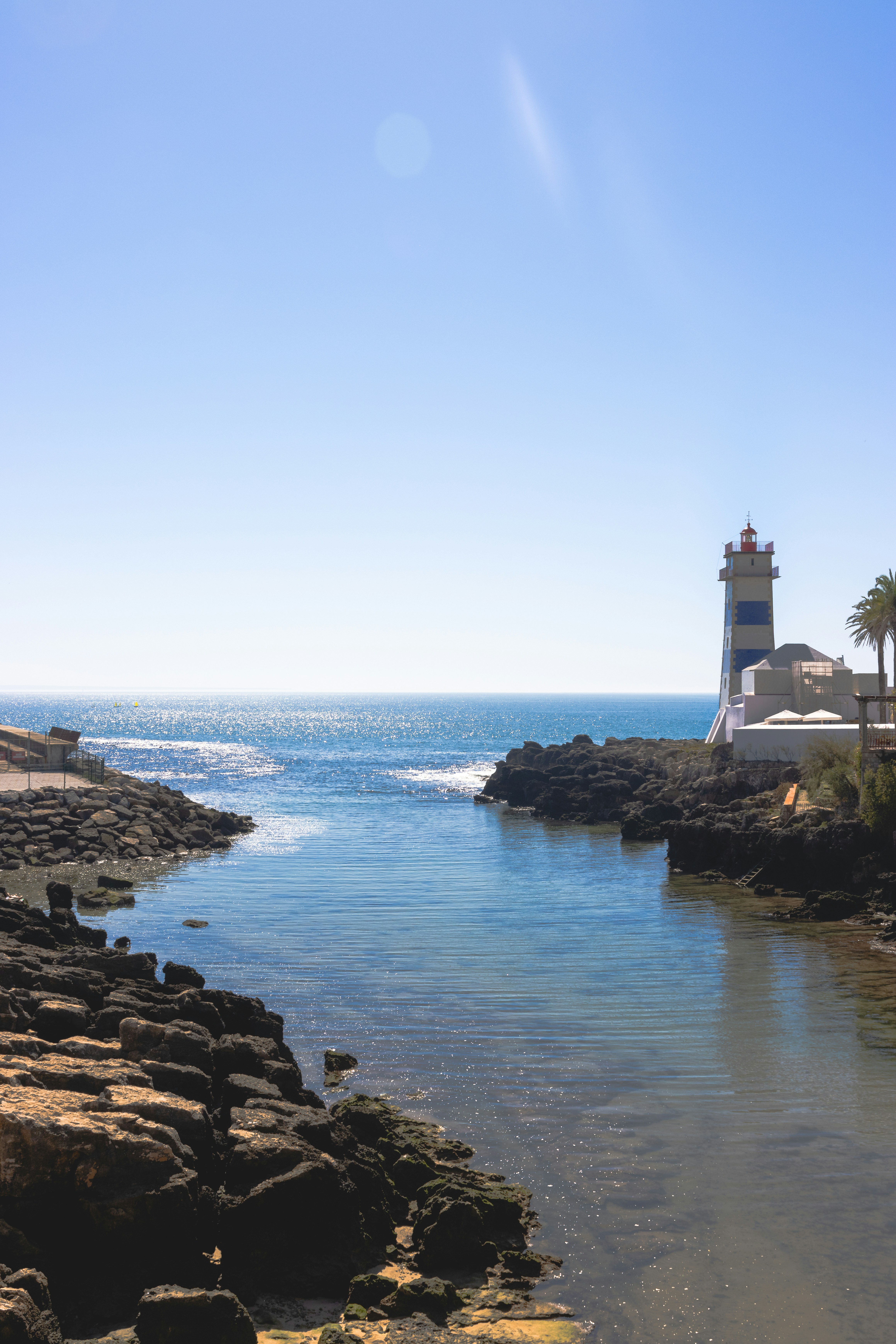 Lighthouse Veil: A Coastal Moment Centered on Light and Path
