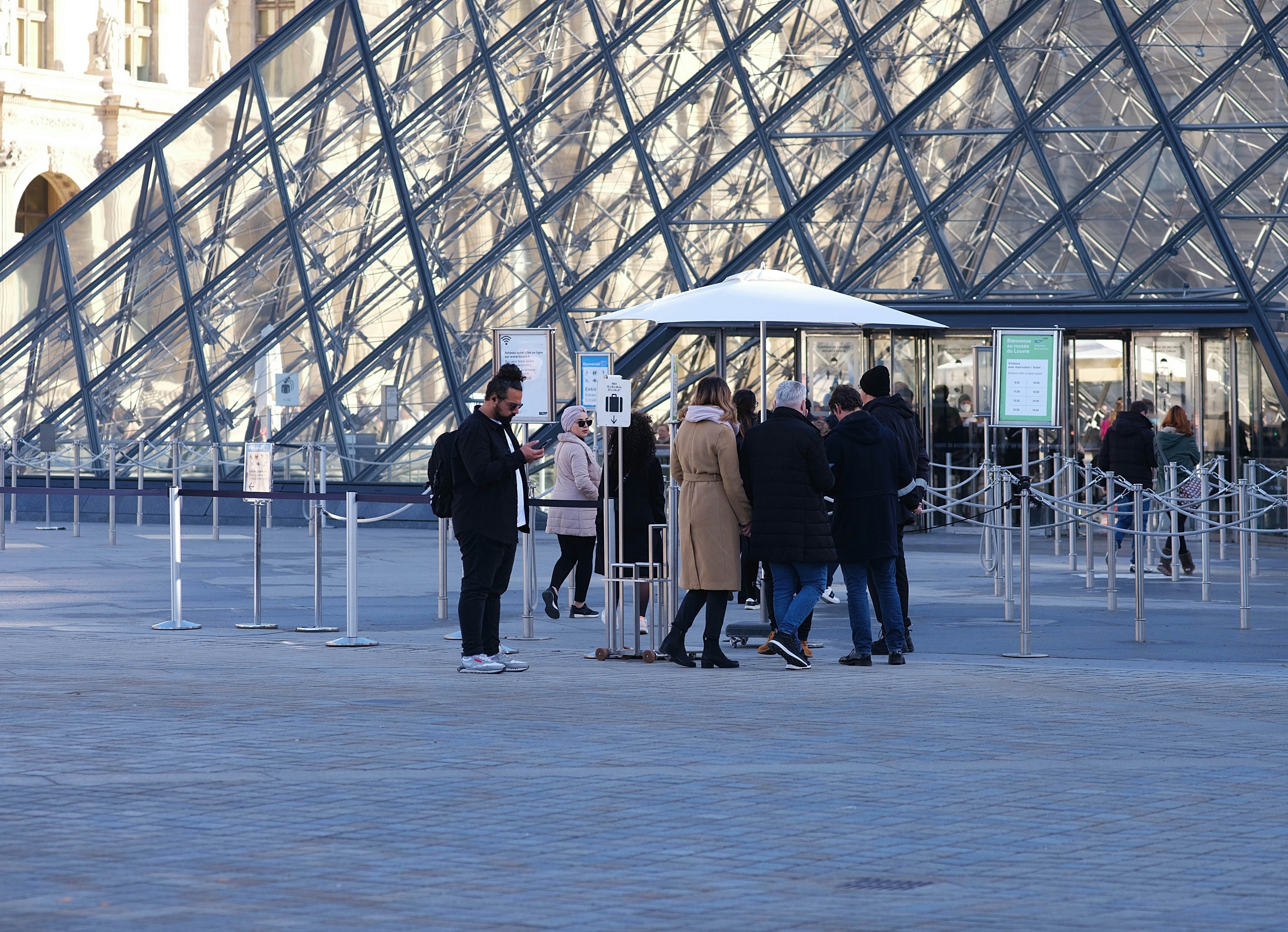 Umbrella Pause at the Louvre Pyramid Forecourt