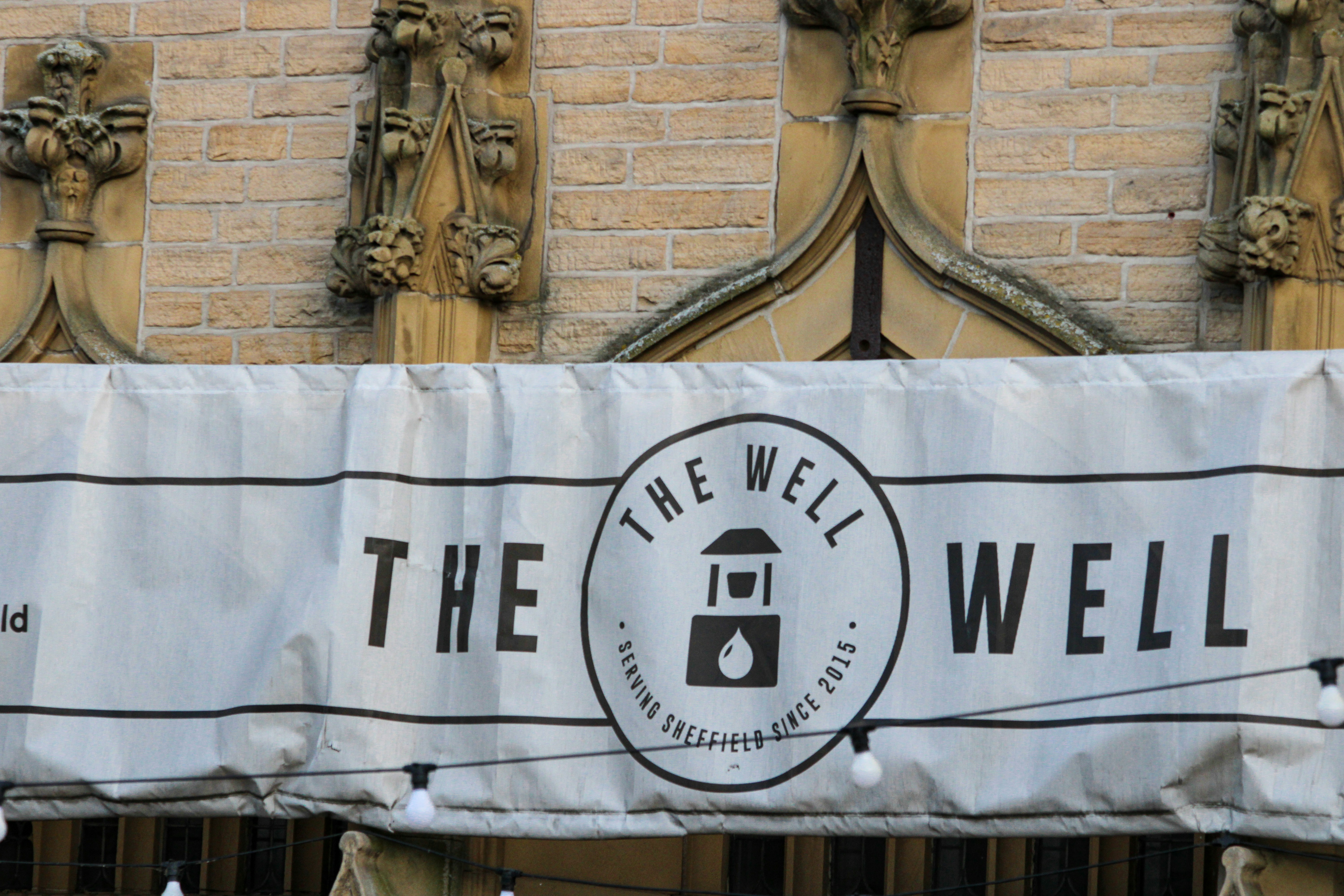 A banner hanging from the side of a building photo – Free Banner Image ...