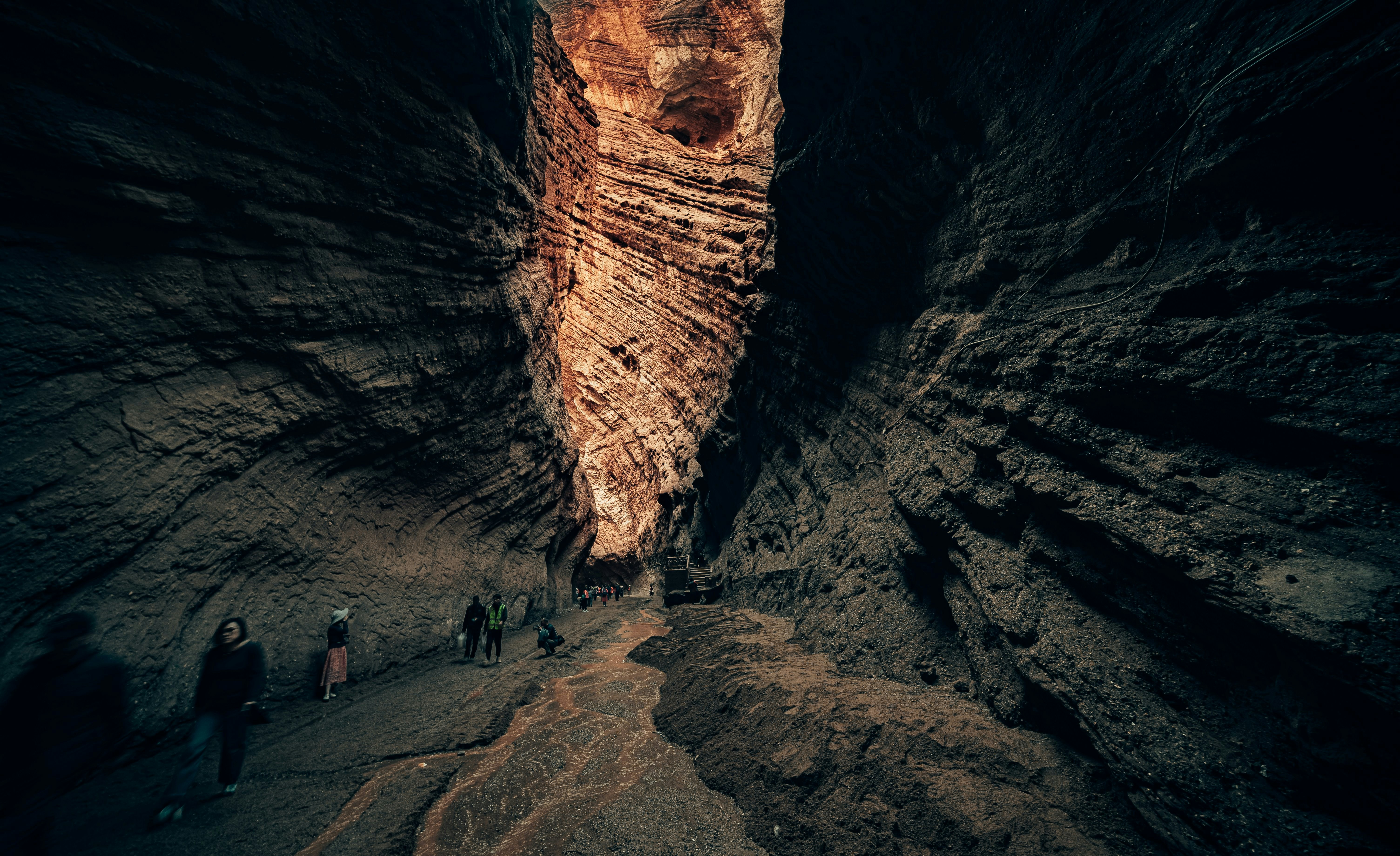 A group of people walking through a narrow canyon photo – Free Nature ...