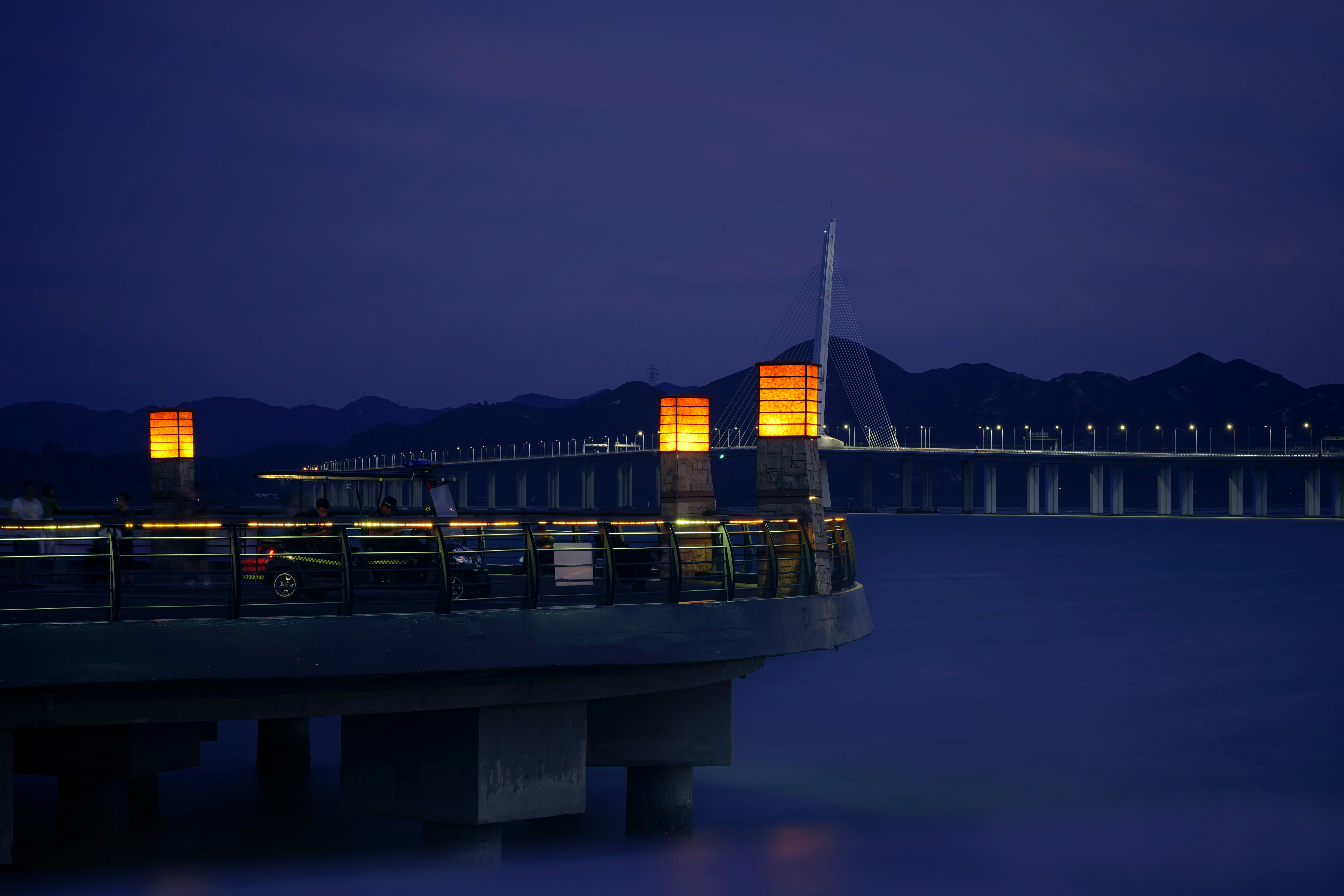 The Shenzhen Bay Observation Deck at night with Hong Kong in the background.