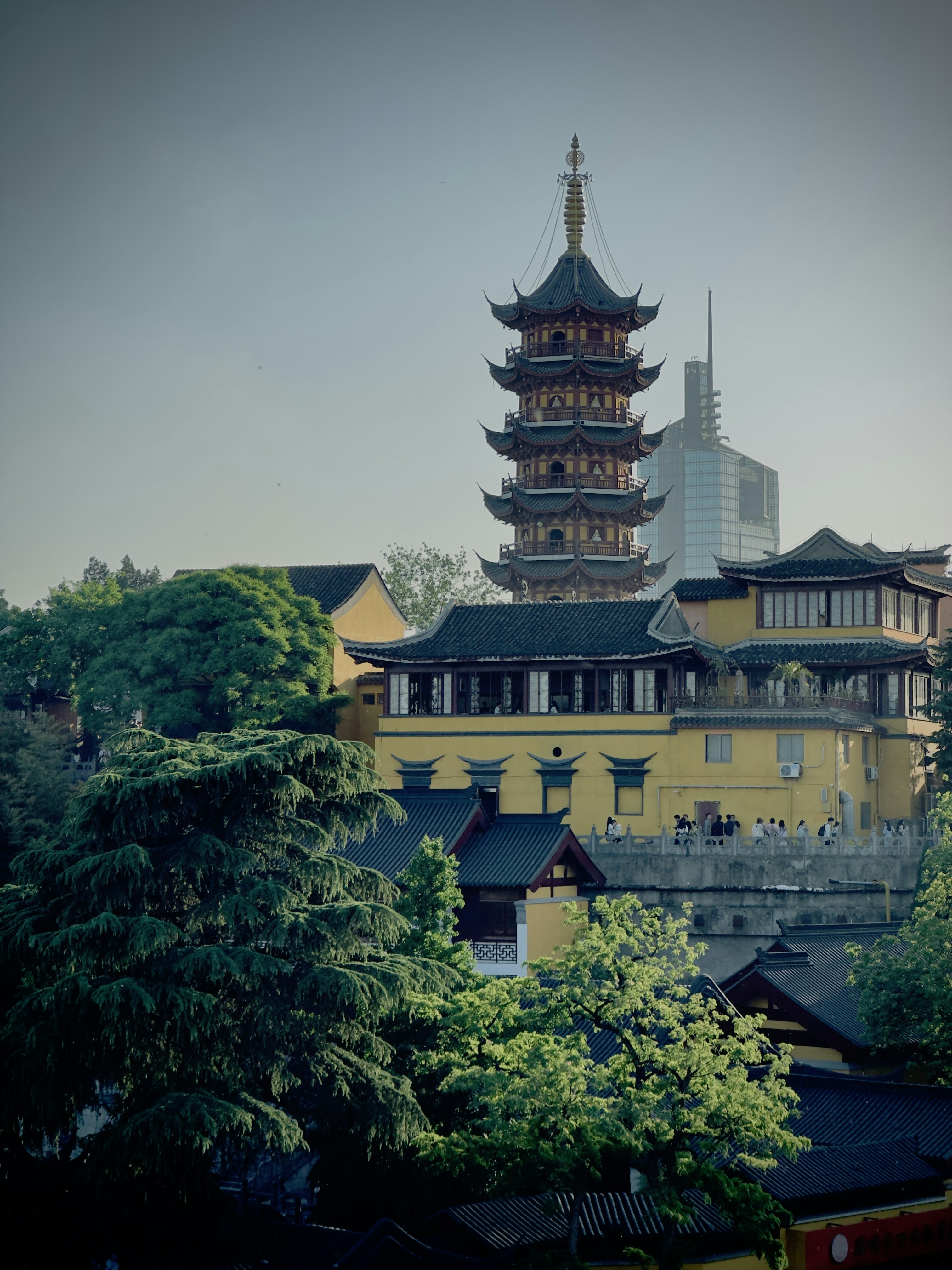A tall yellow building with a tower in the background photo – Free 古鸡鸣寺 ...