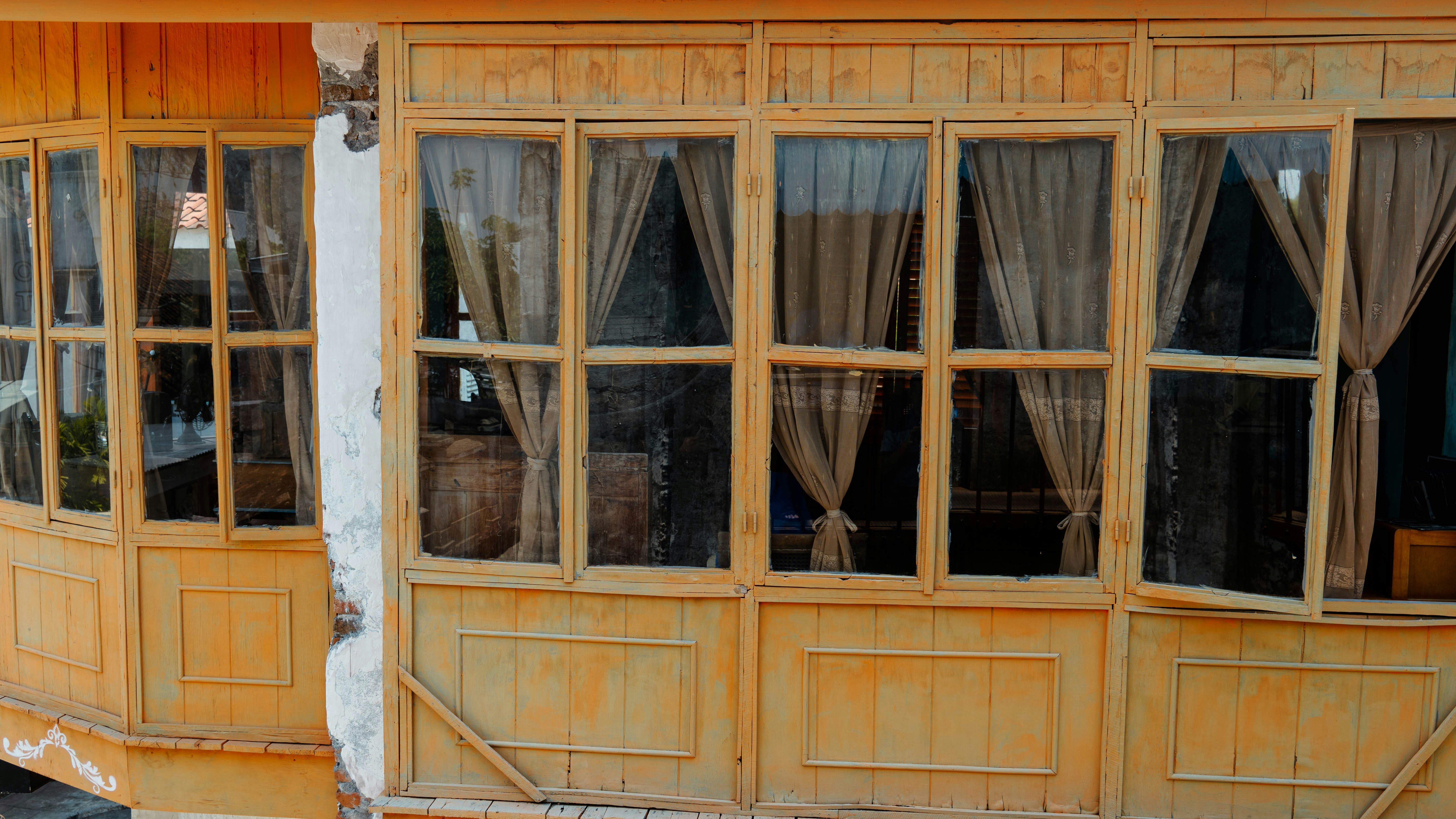 Amber Window Grid on a Weathered Timber Facade