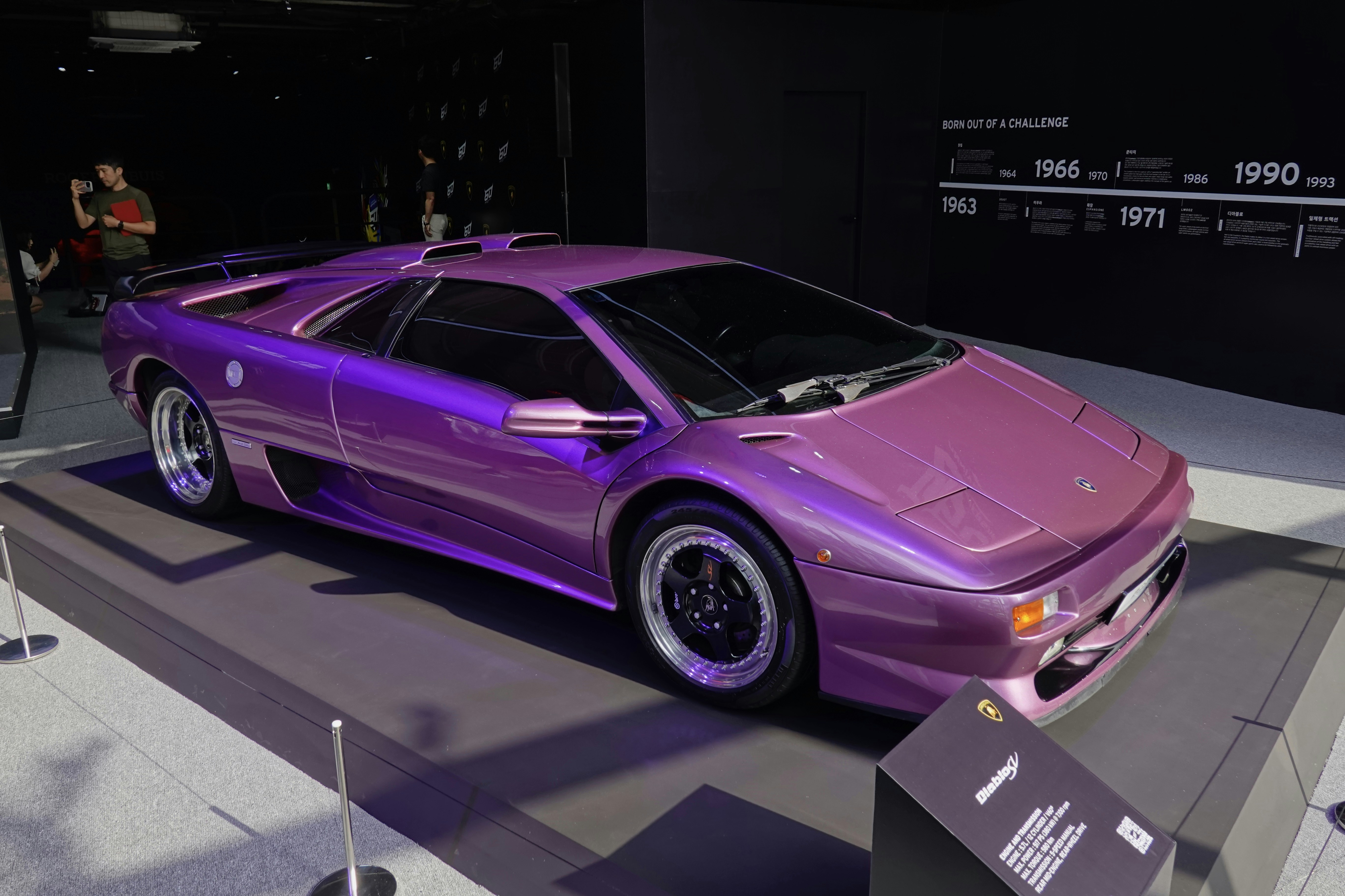 A purple sports car on display at a car show photo – Free Sports car ...