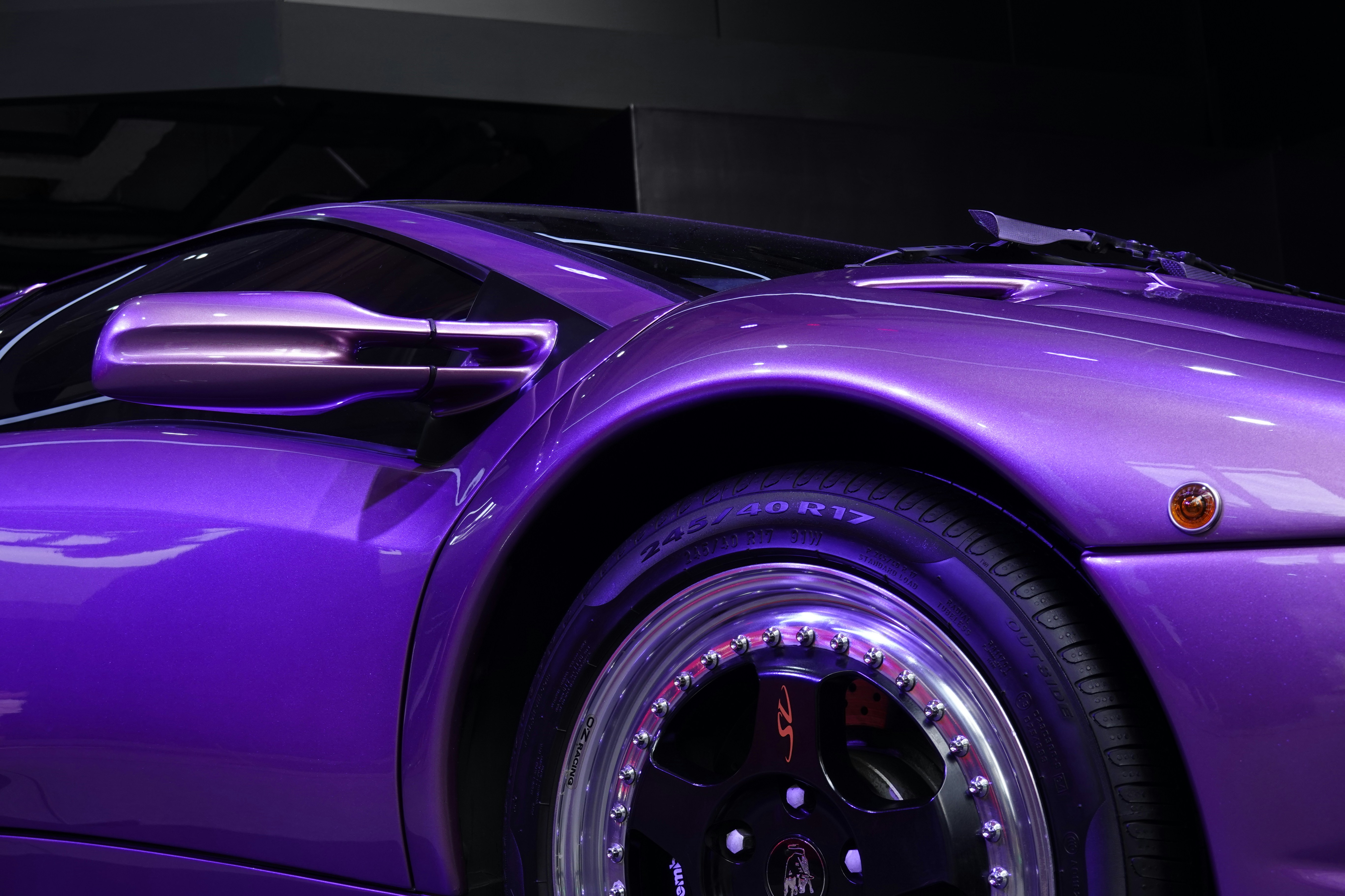 A purple sports car parked in a garage photo – Free Italian cars Image ...