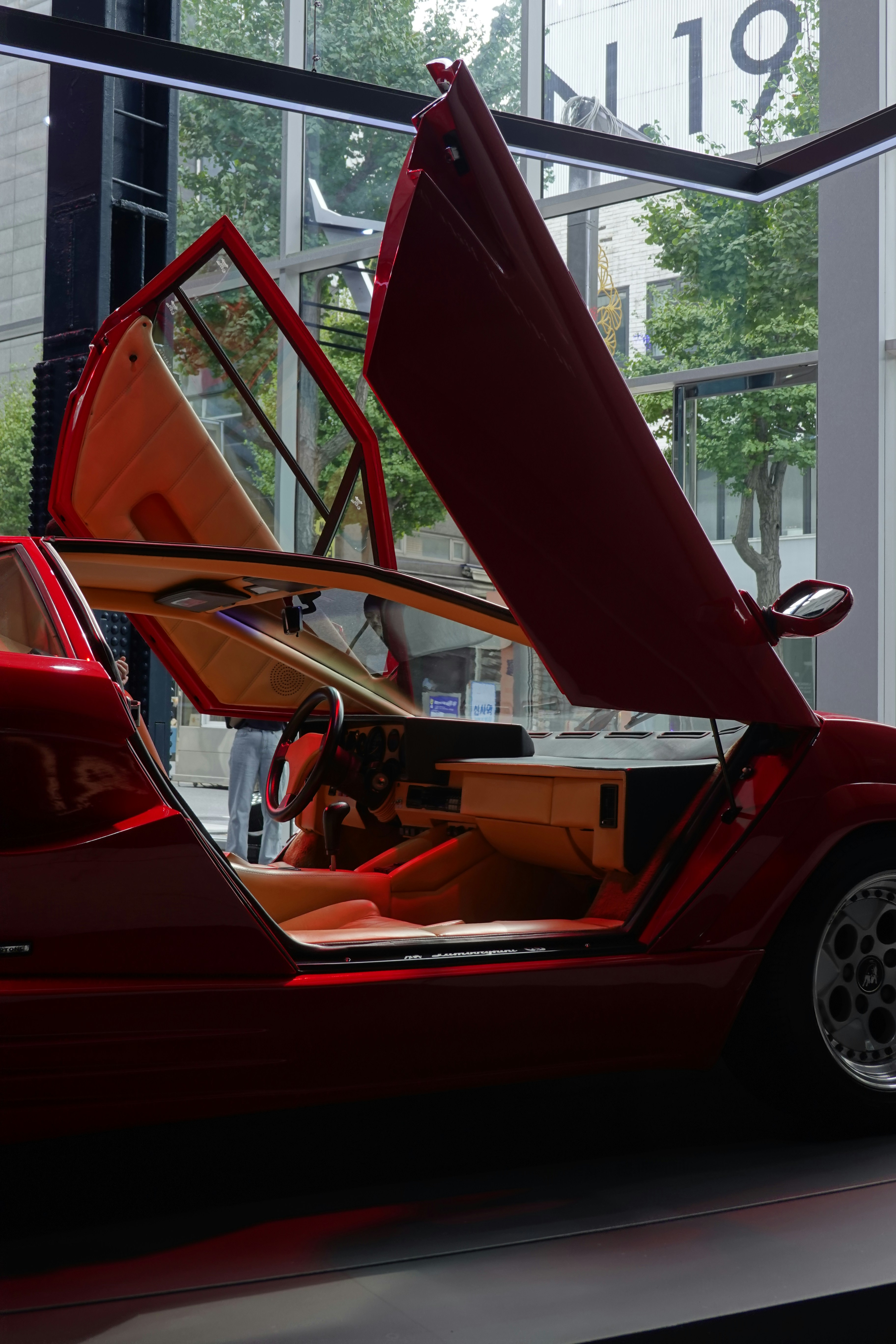 Door-Open Red Exotica: A Supercar Interior Bathed in showroom glow