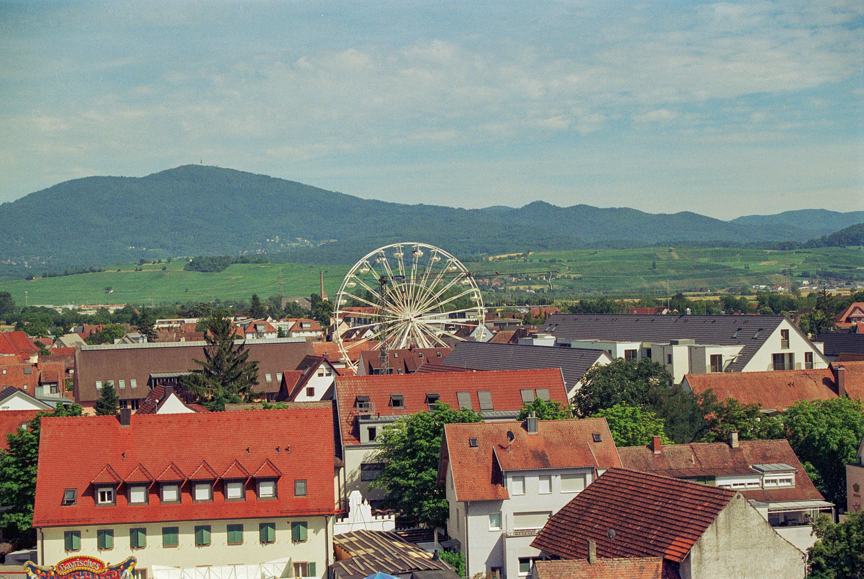 Ferris Wheel Over Red-Tiled Town: A Quiet Horizon