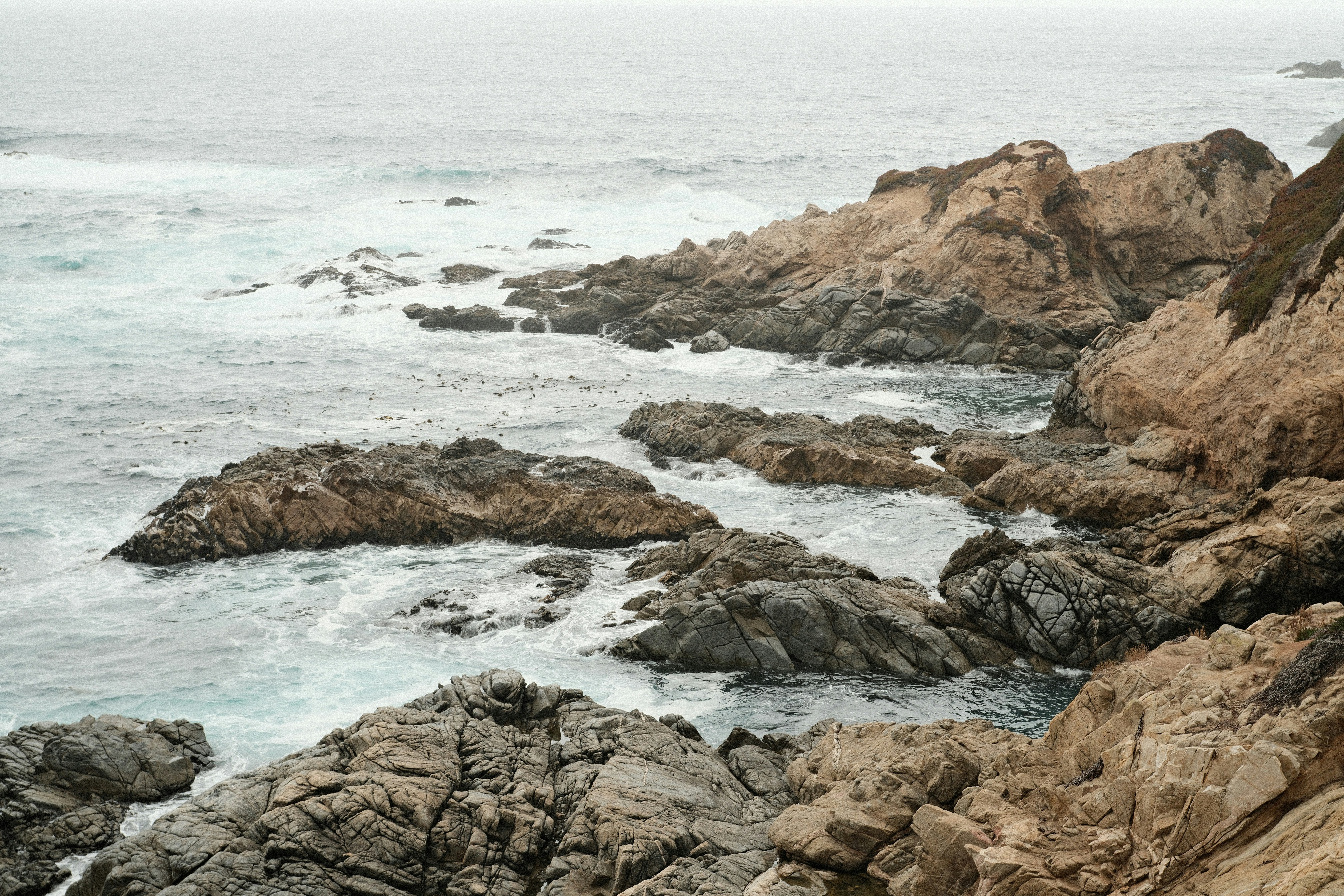 A couple of rocks that are by the water photo – Free Rock Image on Unsplash