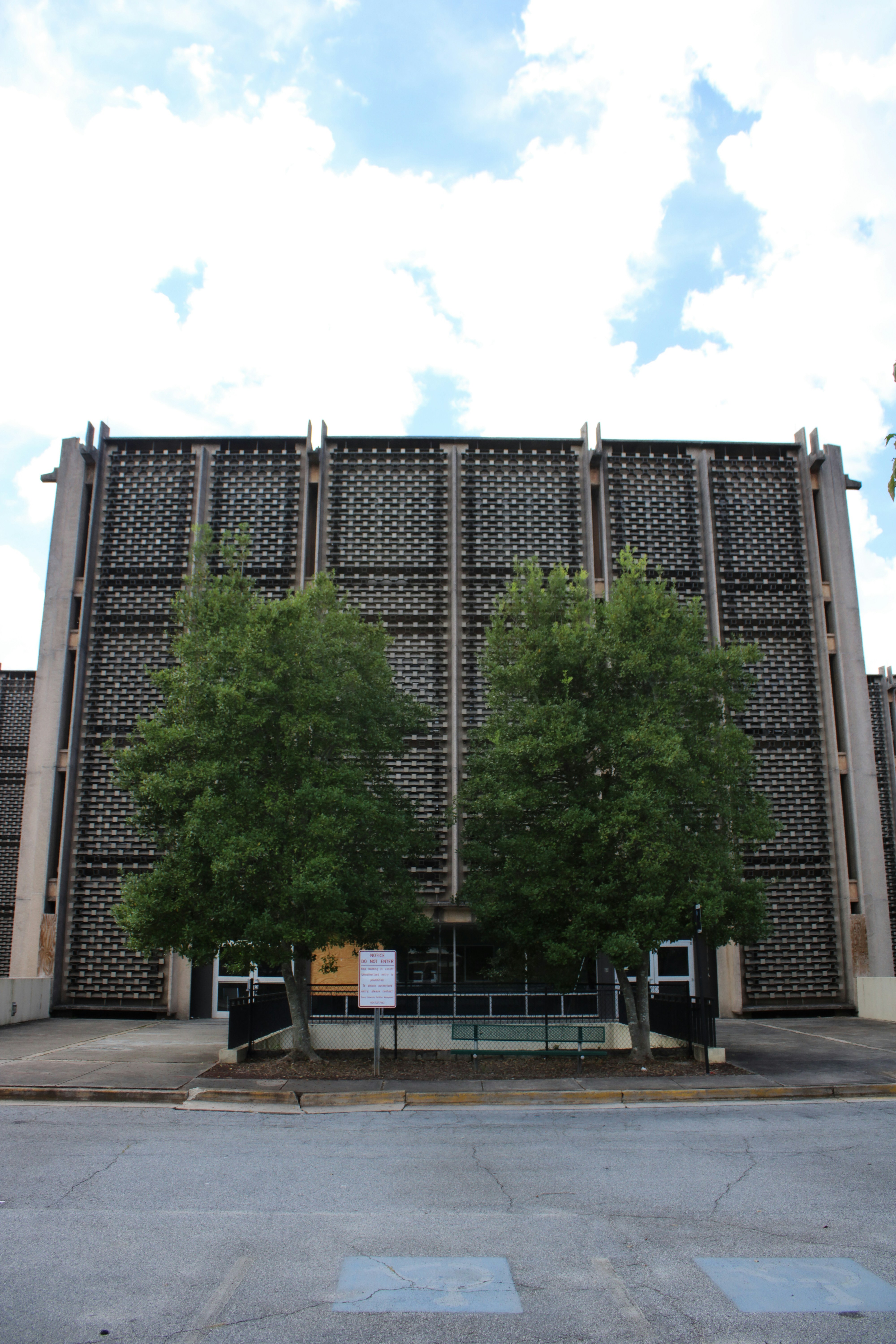 A large building with two trees in front of it photo – Free Stranger ...