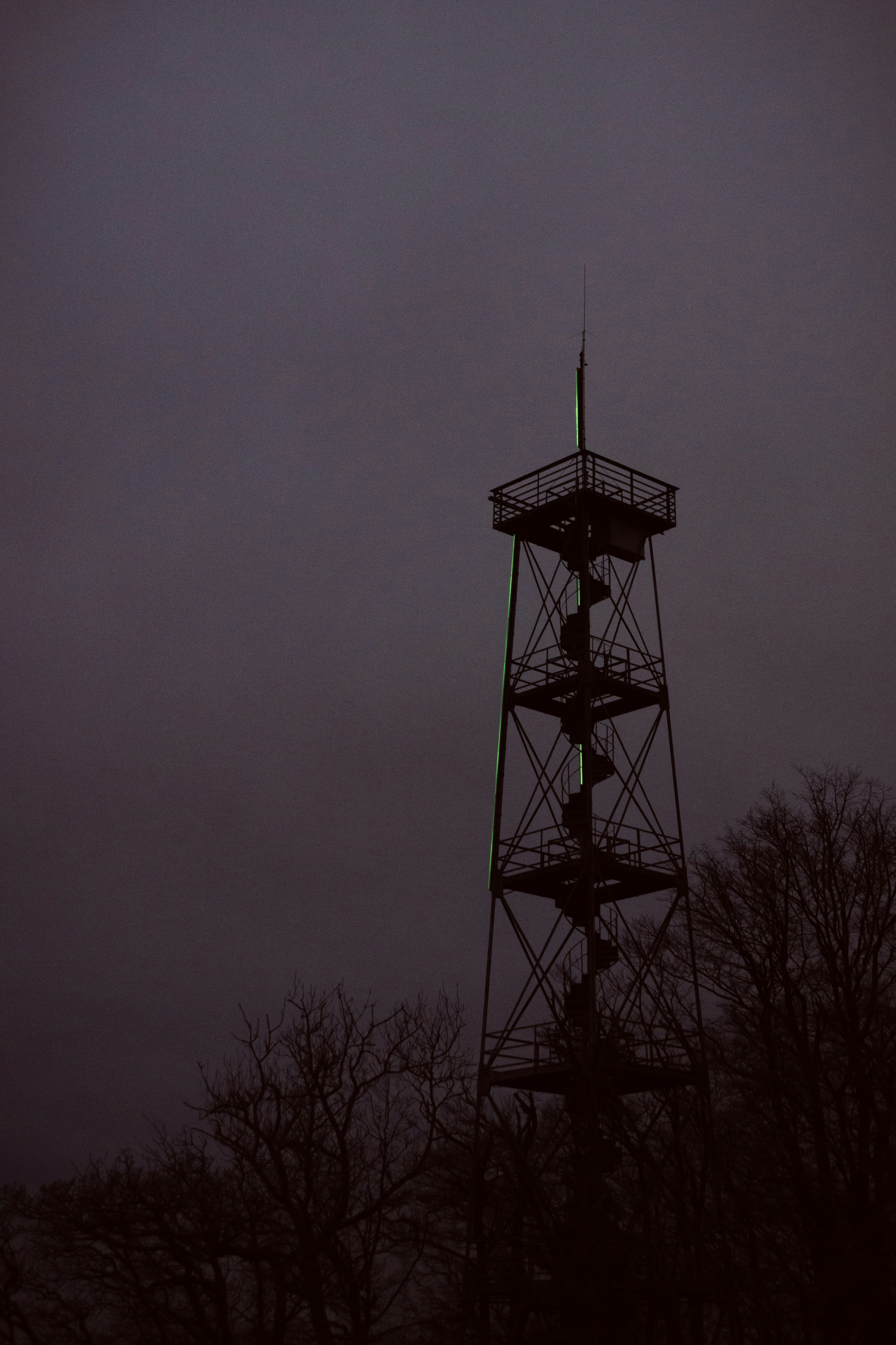 Green-edged Sentinel: A Twilight Tower Against Purple Skies