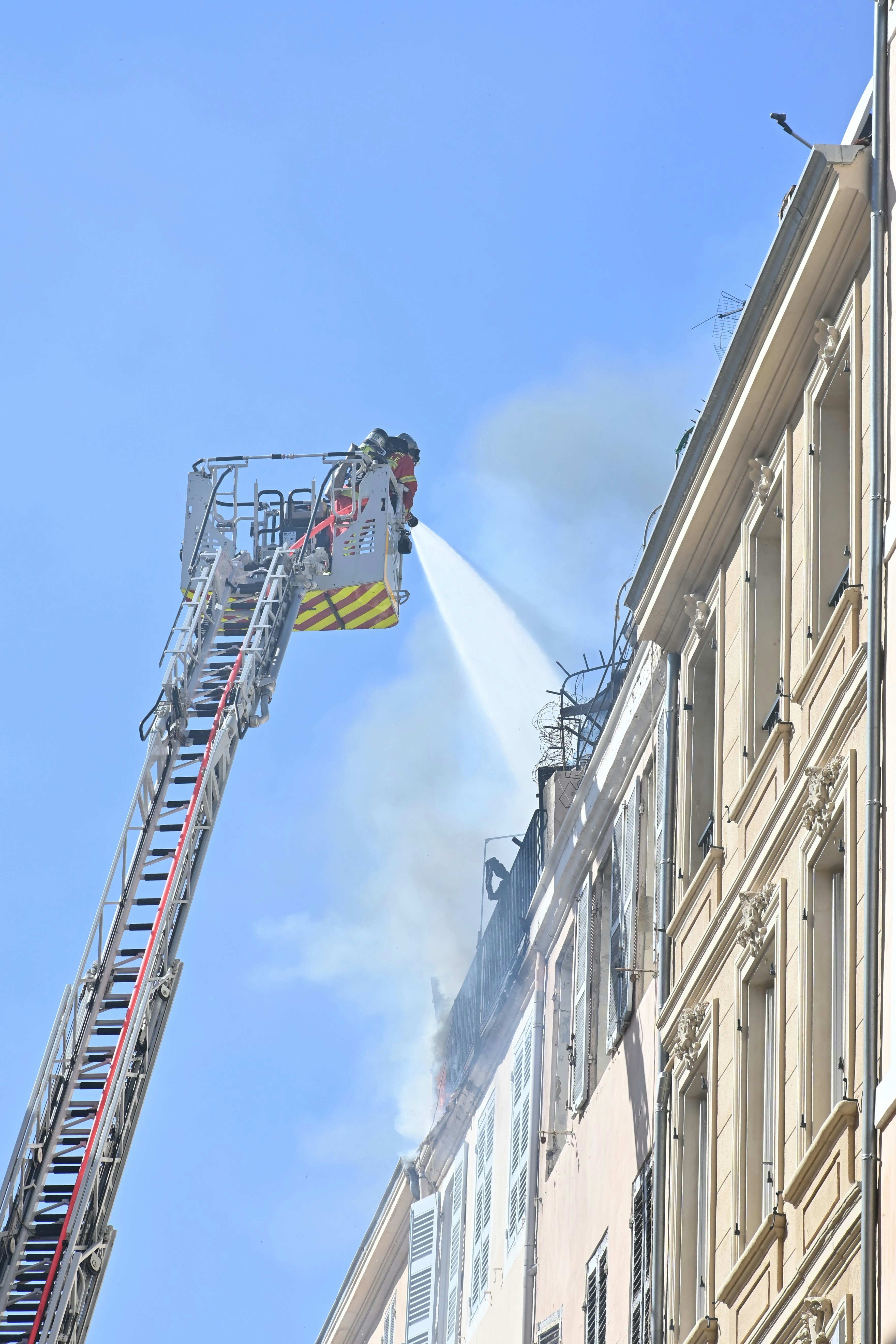 A fire truck spraying water on a building photo – Free City Image on ...