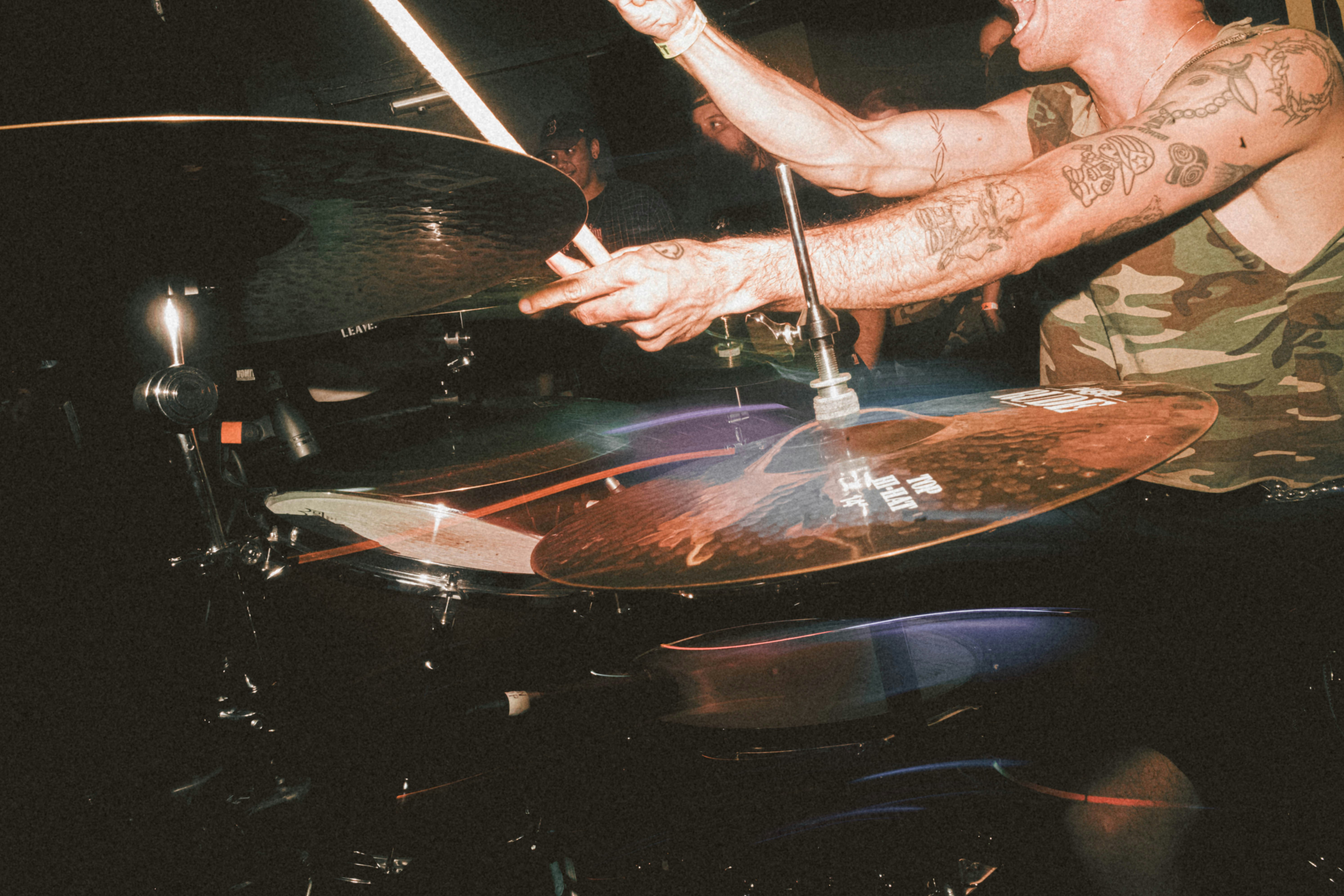 A man with tattoos playing a drum set photo – Free Musical instrument ...