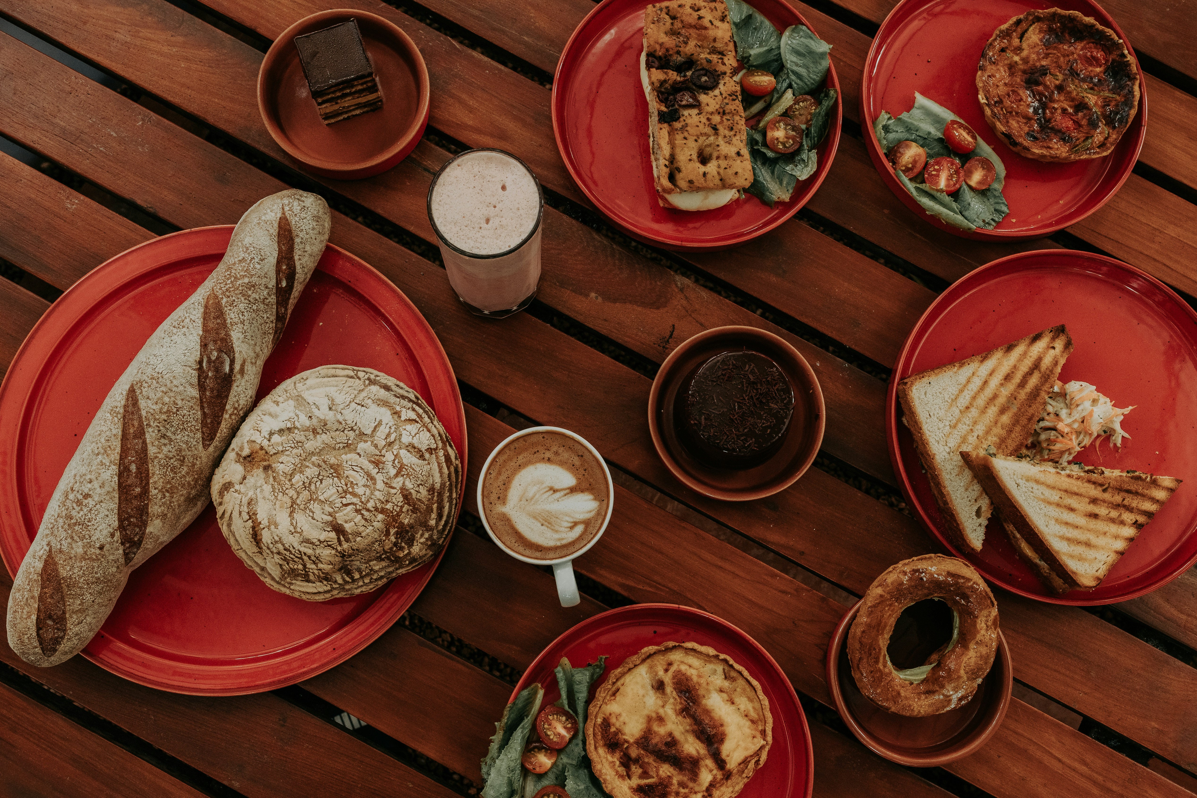 A table topped with plates of food and drinks photo – Free Food and ...