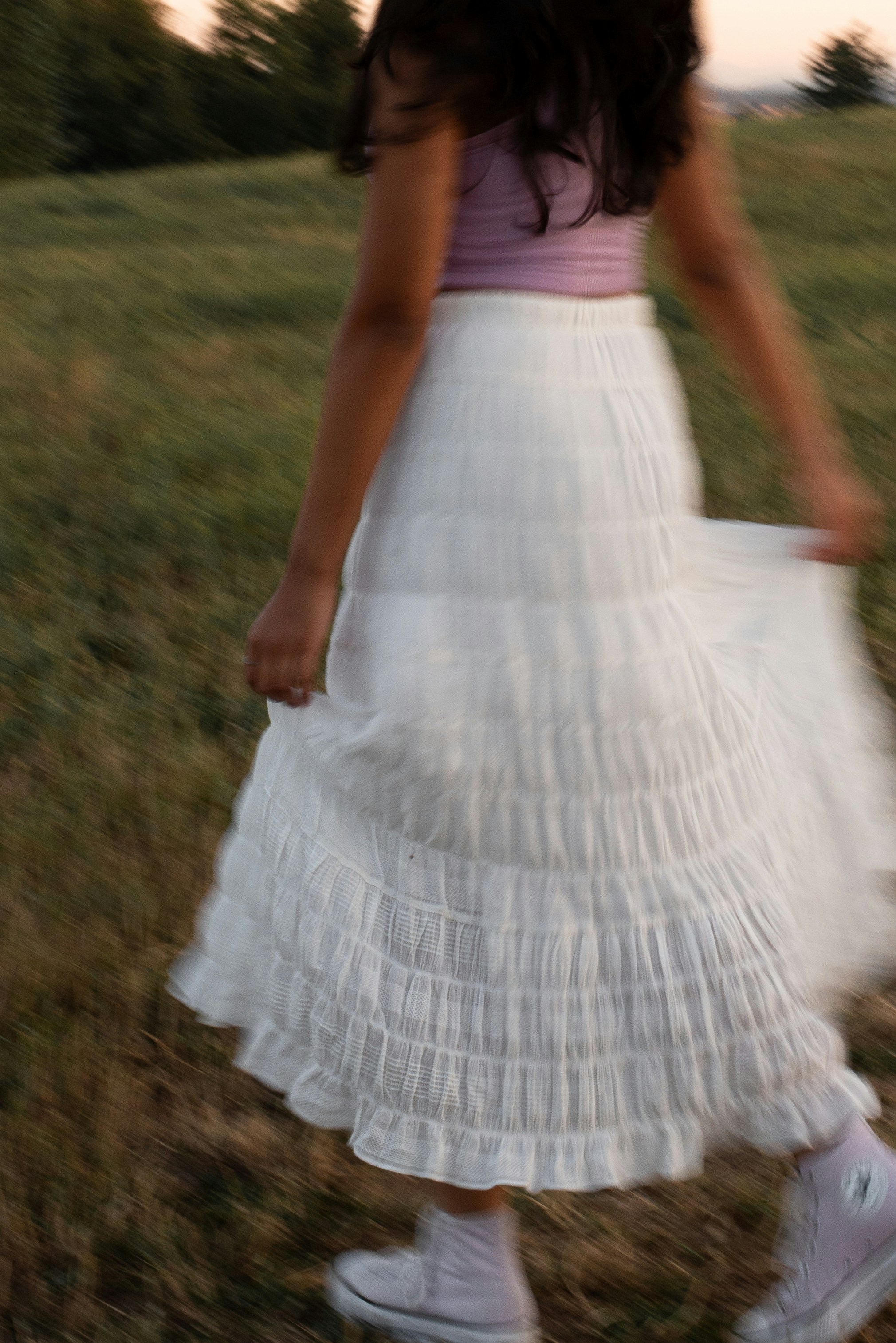 White Tiered Skirt in Slow-Motion Stroll Across a Sunlit Meadow