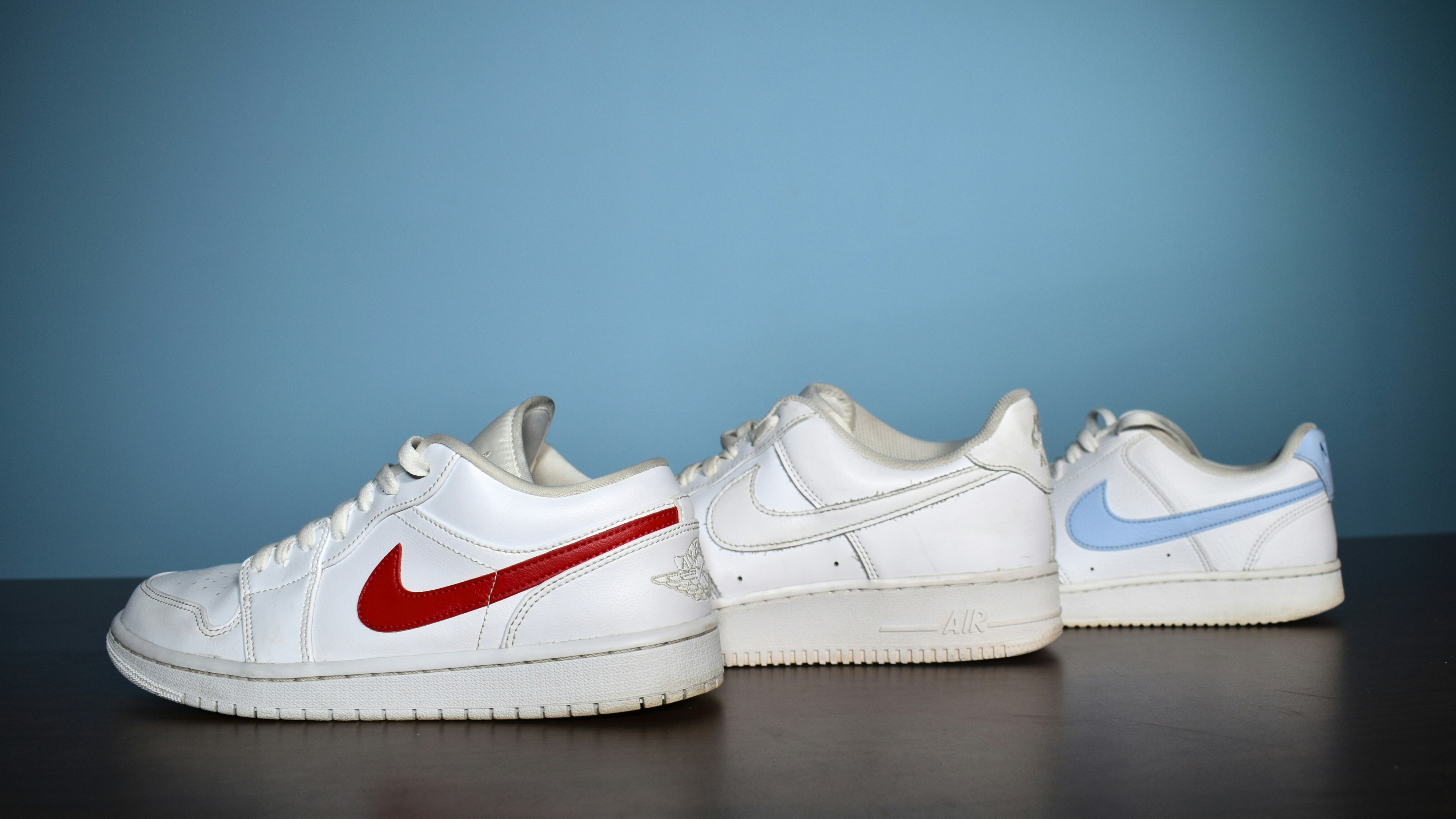 A pair of white sneakers with a red and blue nike logo photo – Free ...