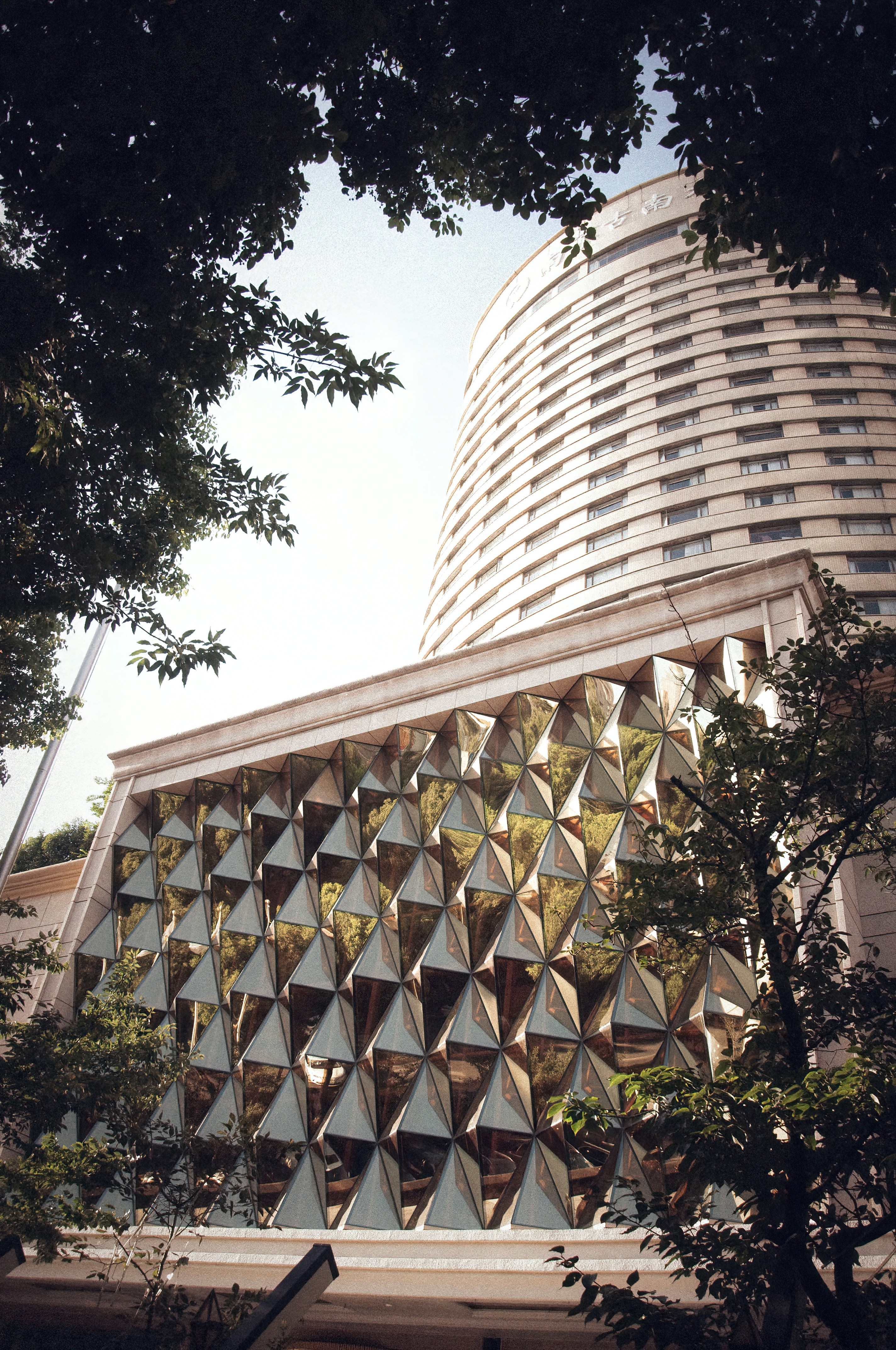 A large building with a triangular design on the side of it photo ...