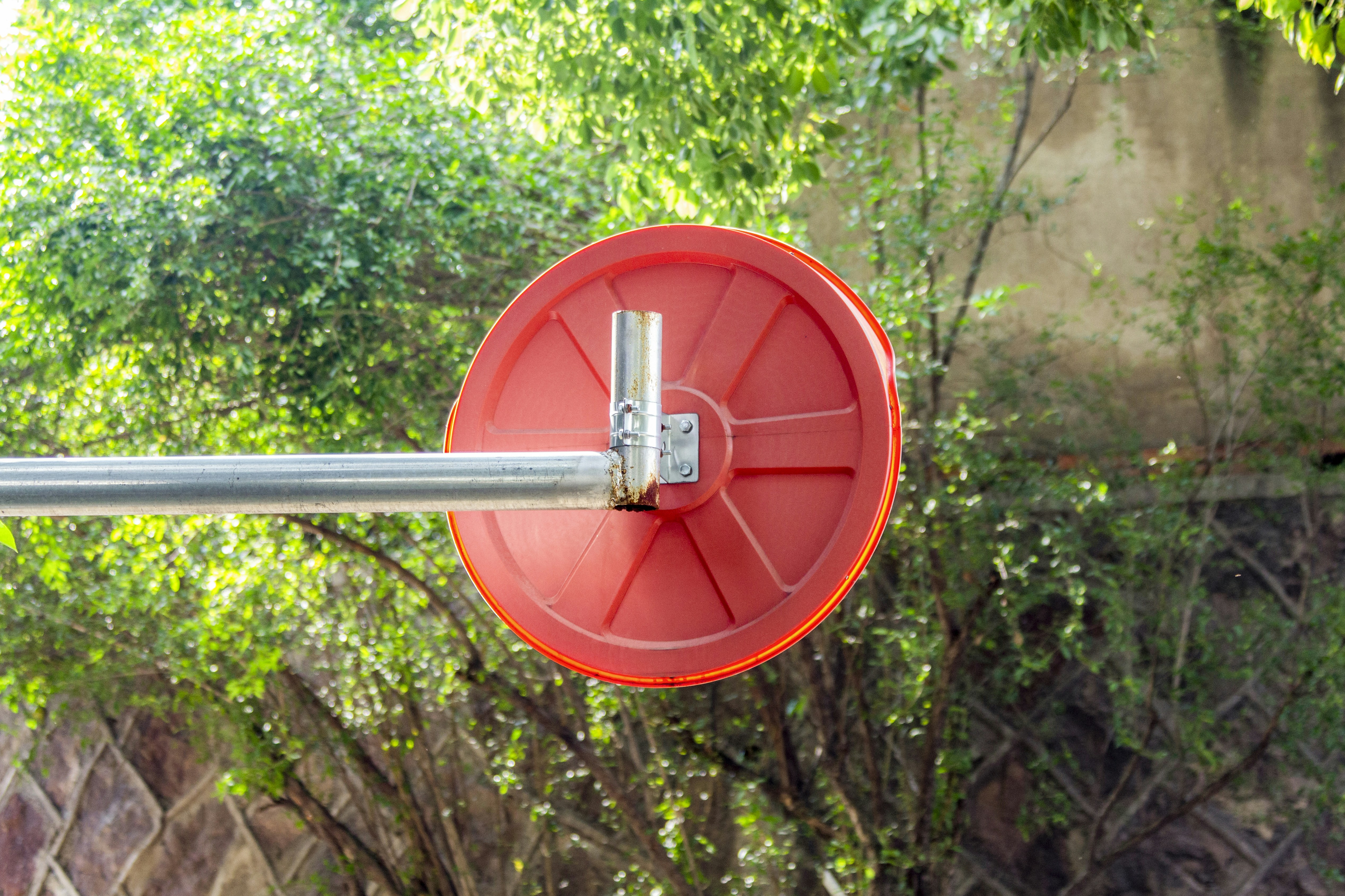 A metal pole with a red wheel attached to it photo – Free Red Image on ...