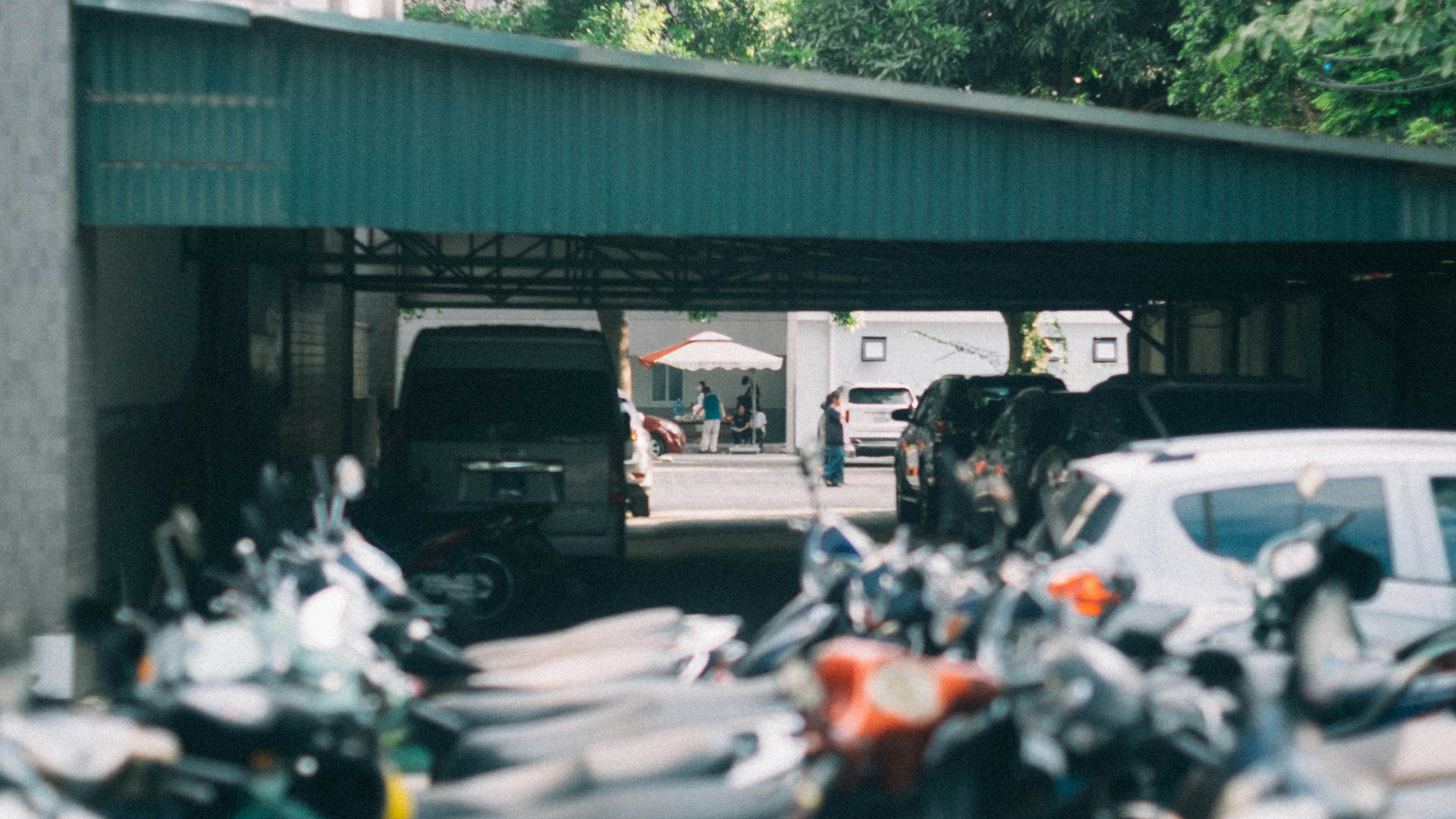Under the Carport: A Corridor of Motorcycles and a Quiet Street