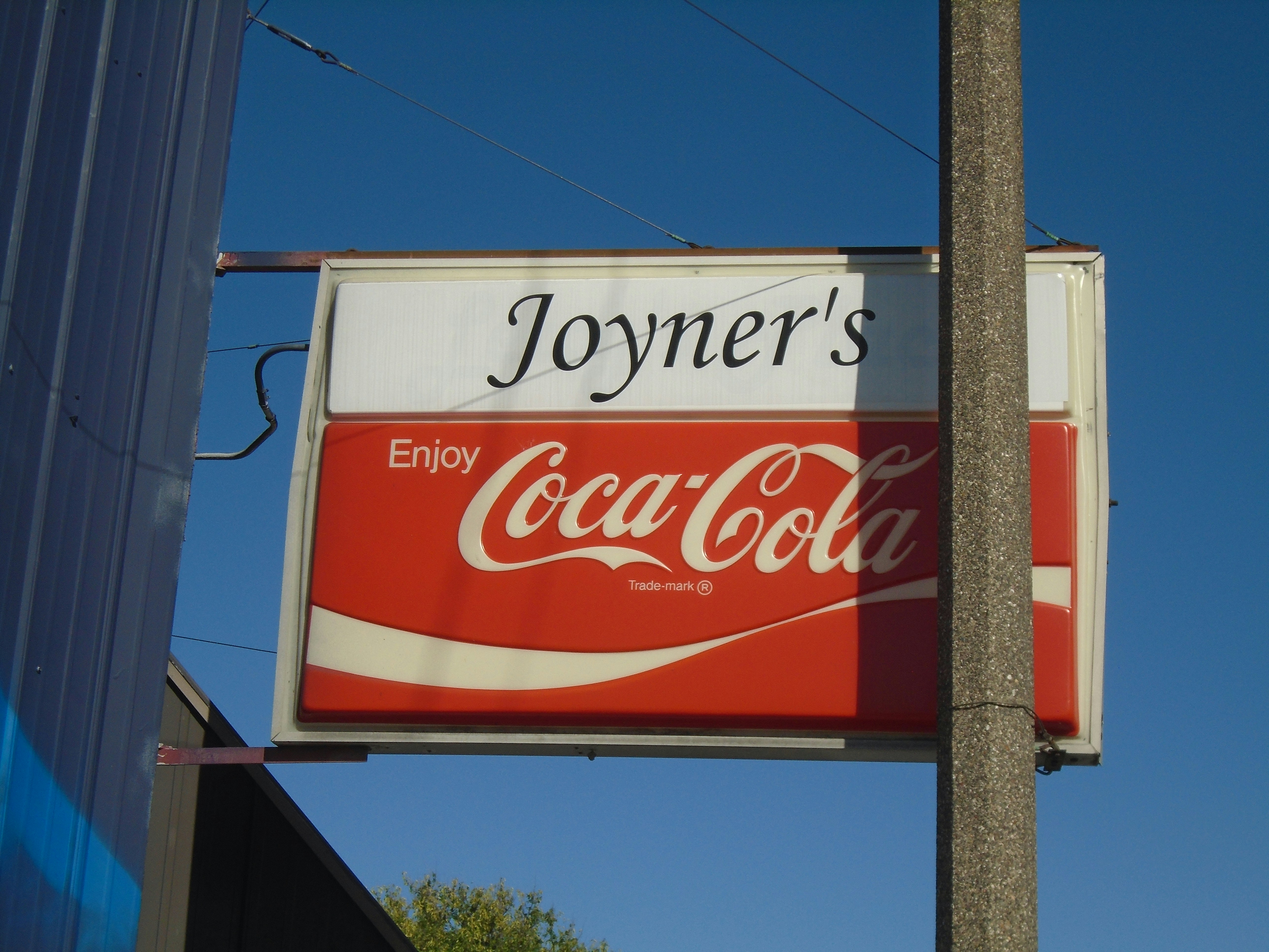 Joyner's Coca-Cola Sign Braced by a Clear Blue Sky