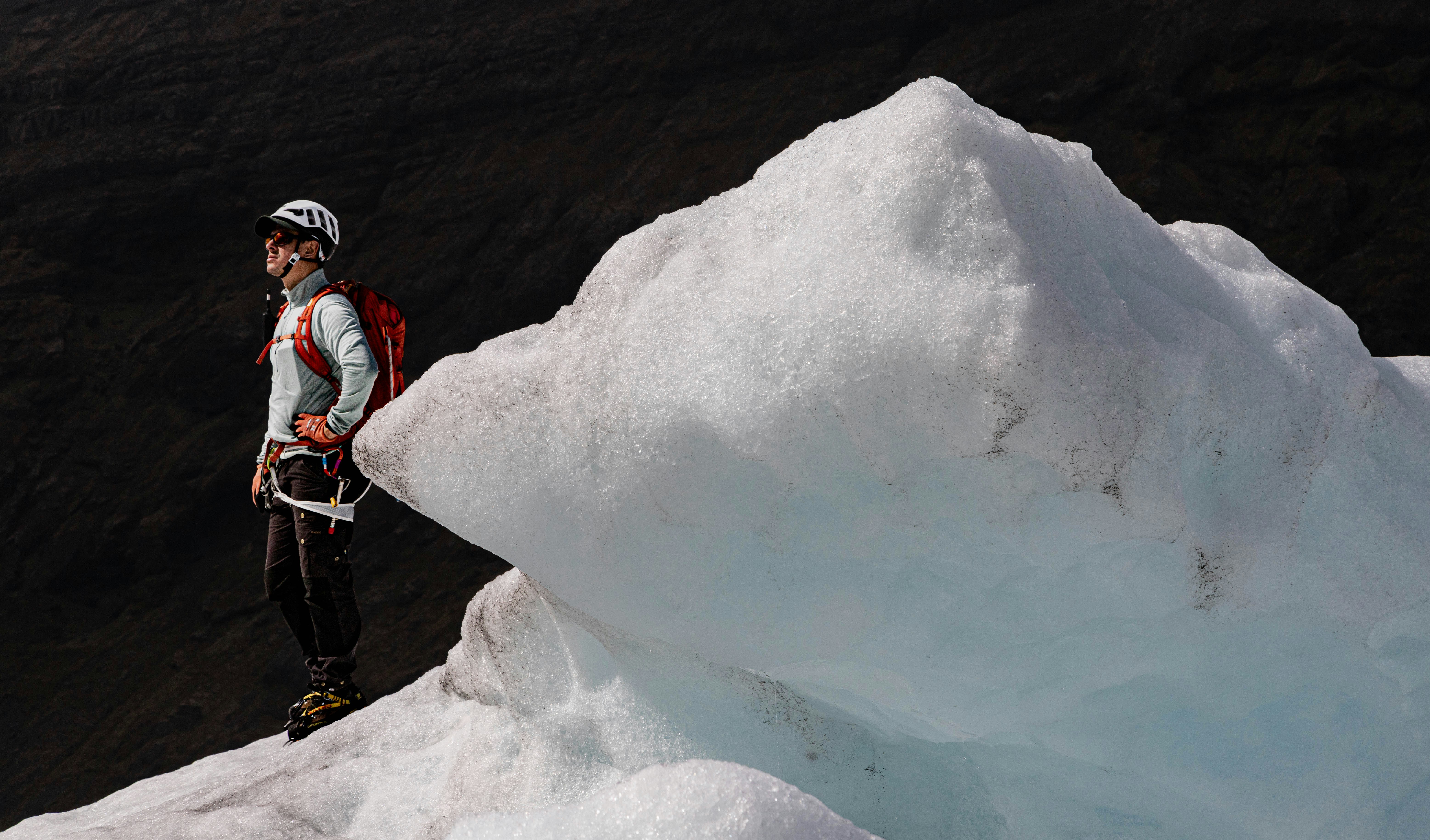 Edge of Ice: A Climber Pauses on a Curved Snow Crest