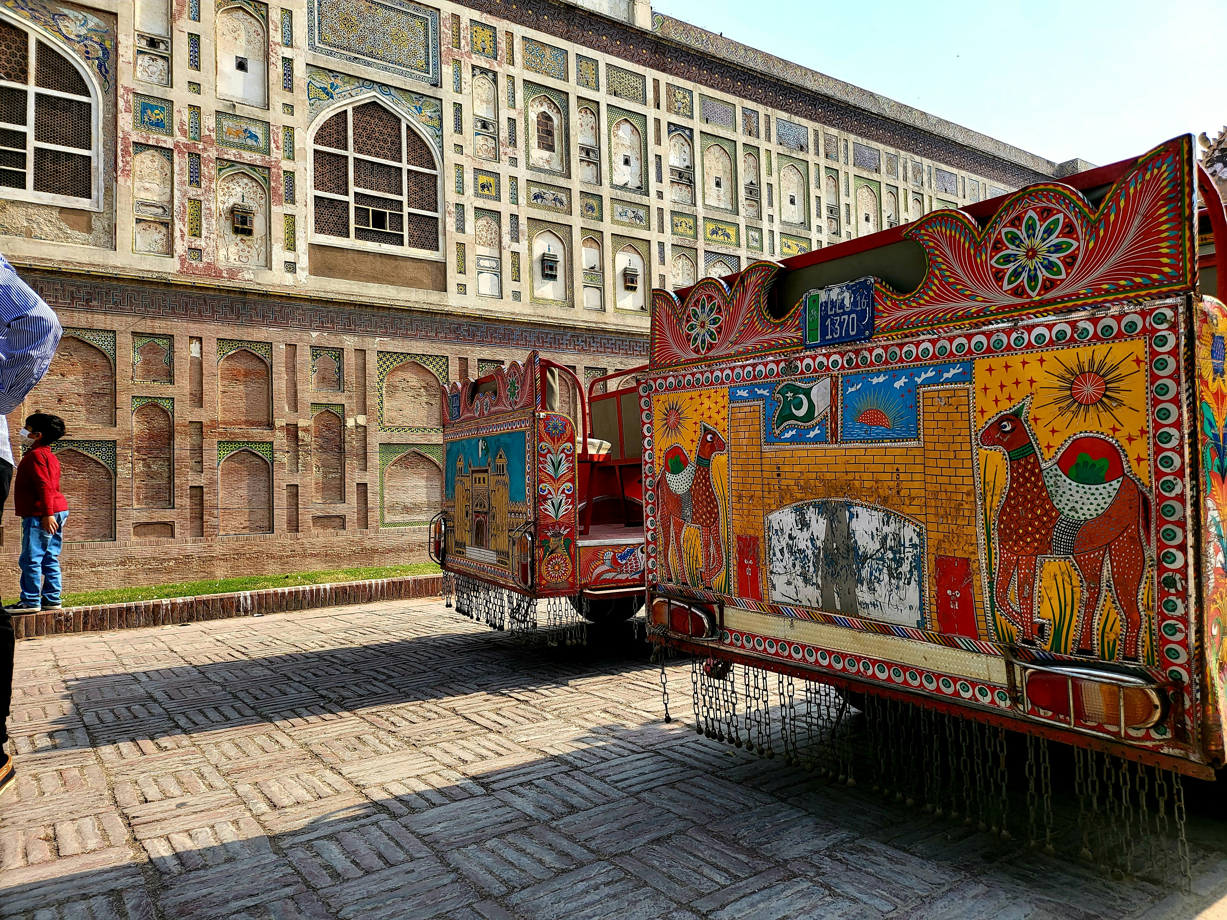Colorful Carts in a Sunlit Courtyard with Historic Facade
