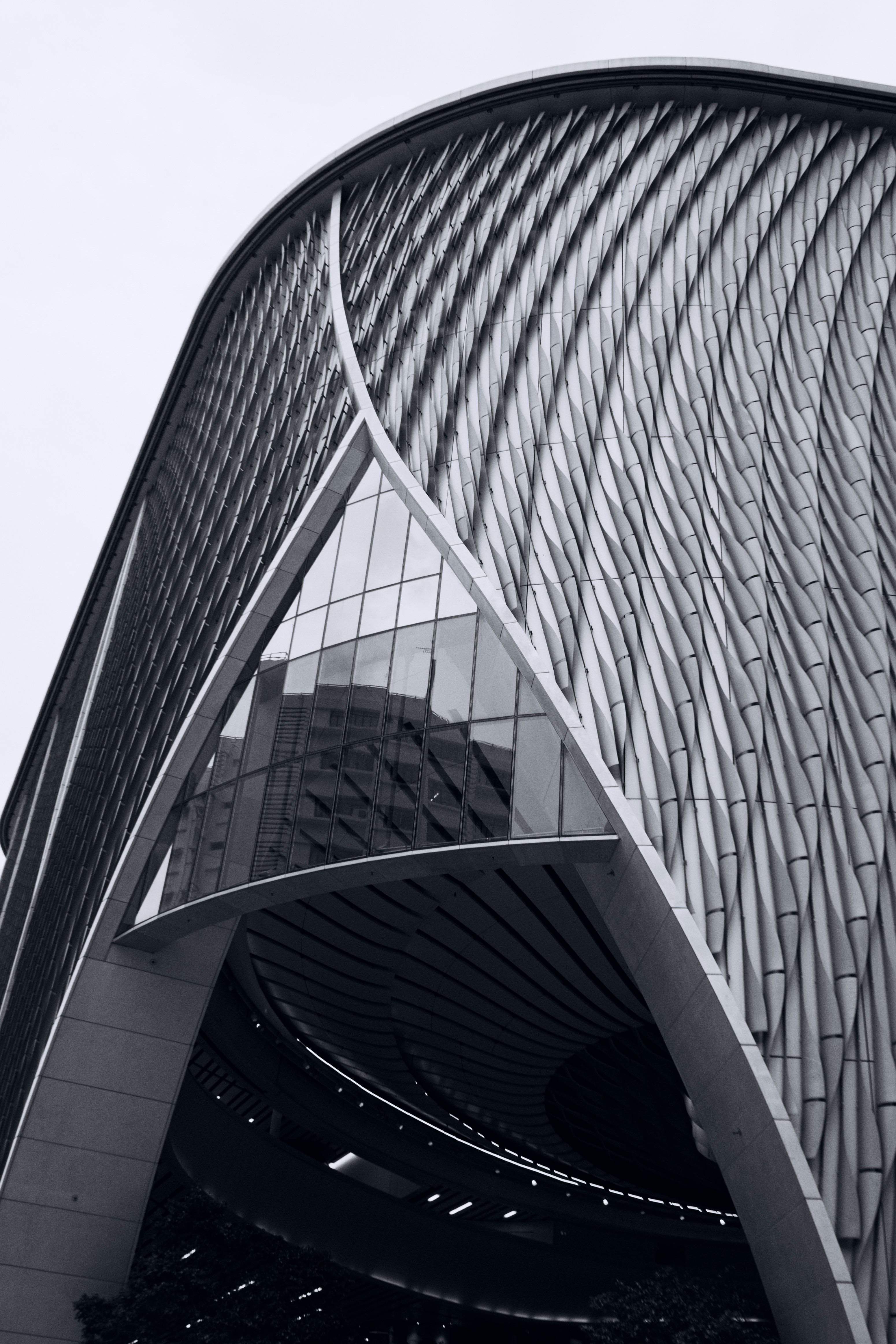 A very tall building with a curved roof photo – Free Hong kong Image on ...
