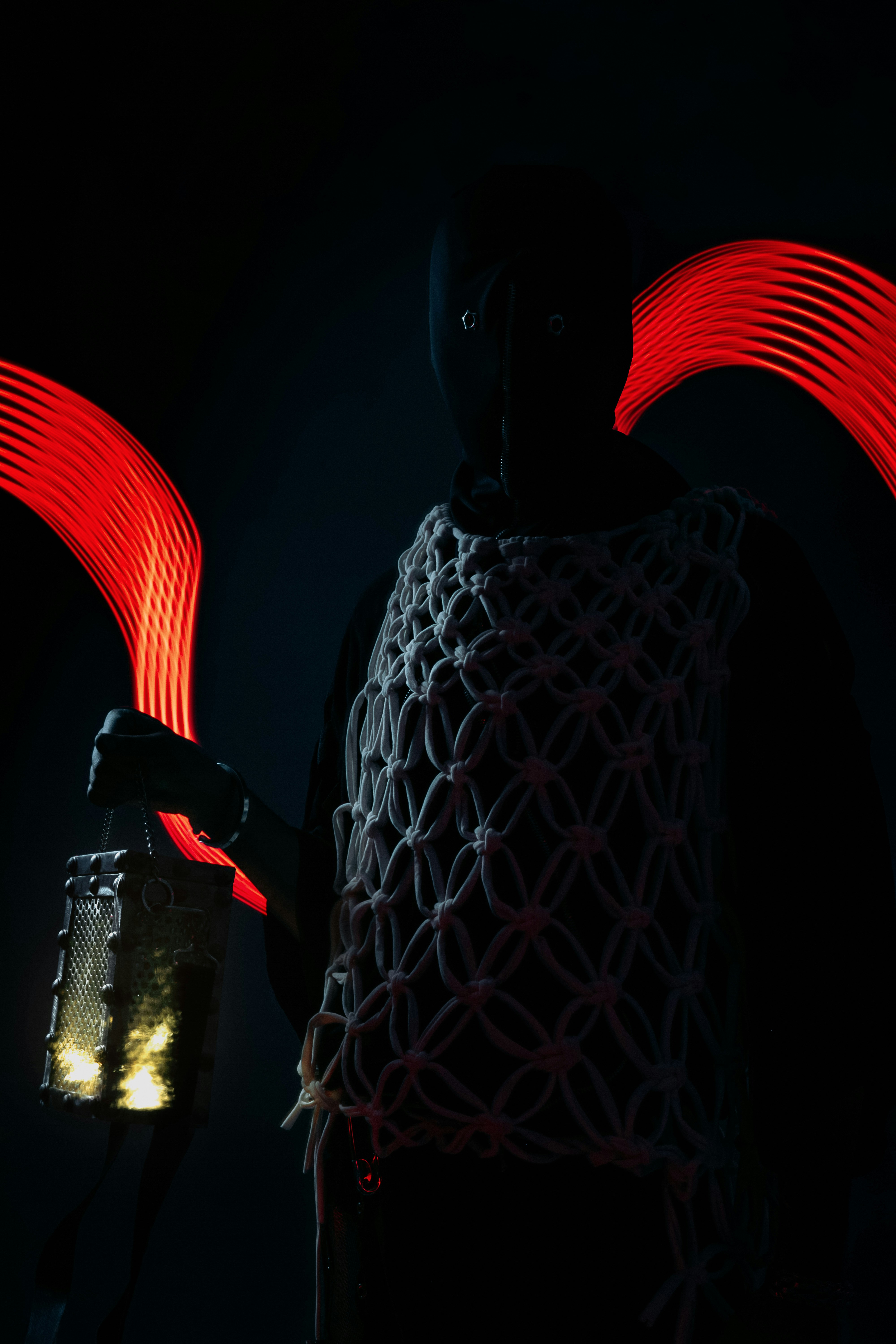 A person holding a lantern with red lights on it photo – Free Light ...