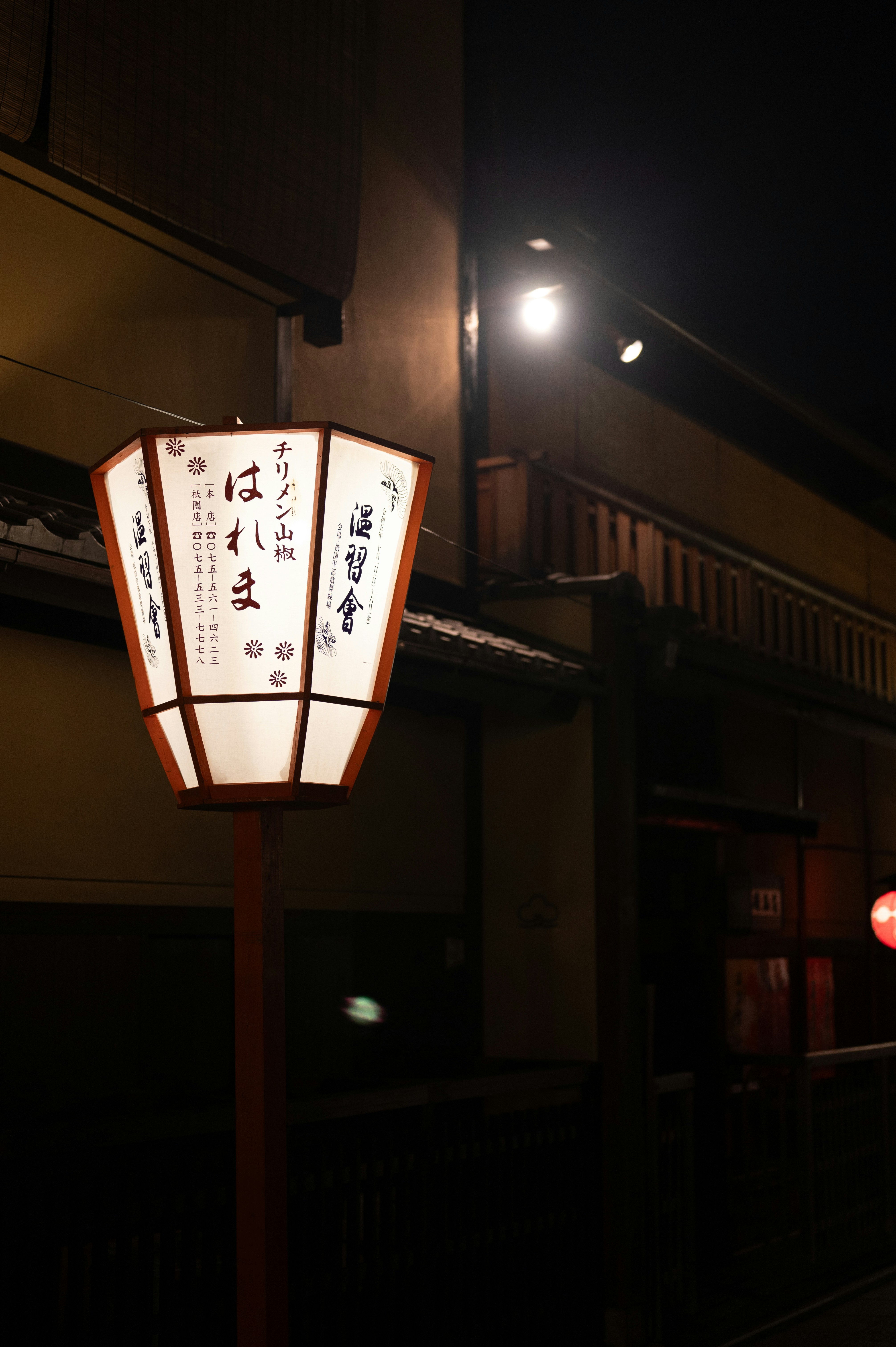 Lantern Pulse: Quiet Night Along a Wooden Facade Street