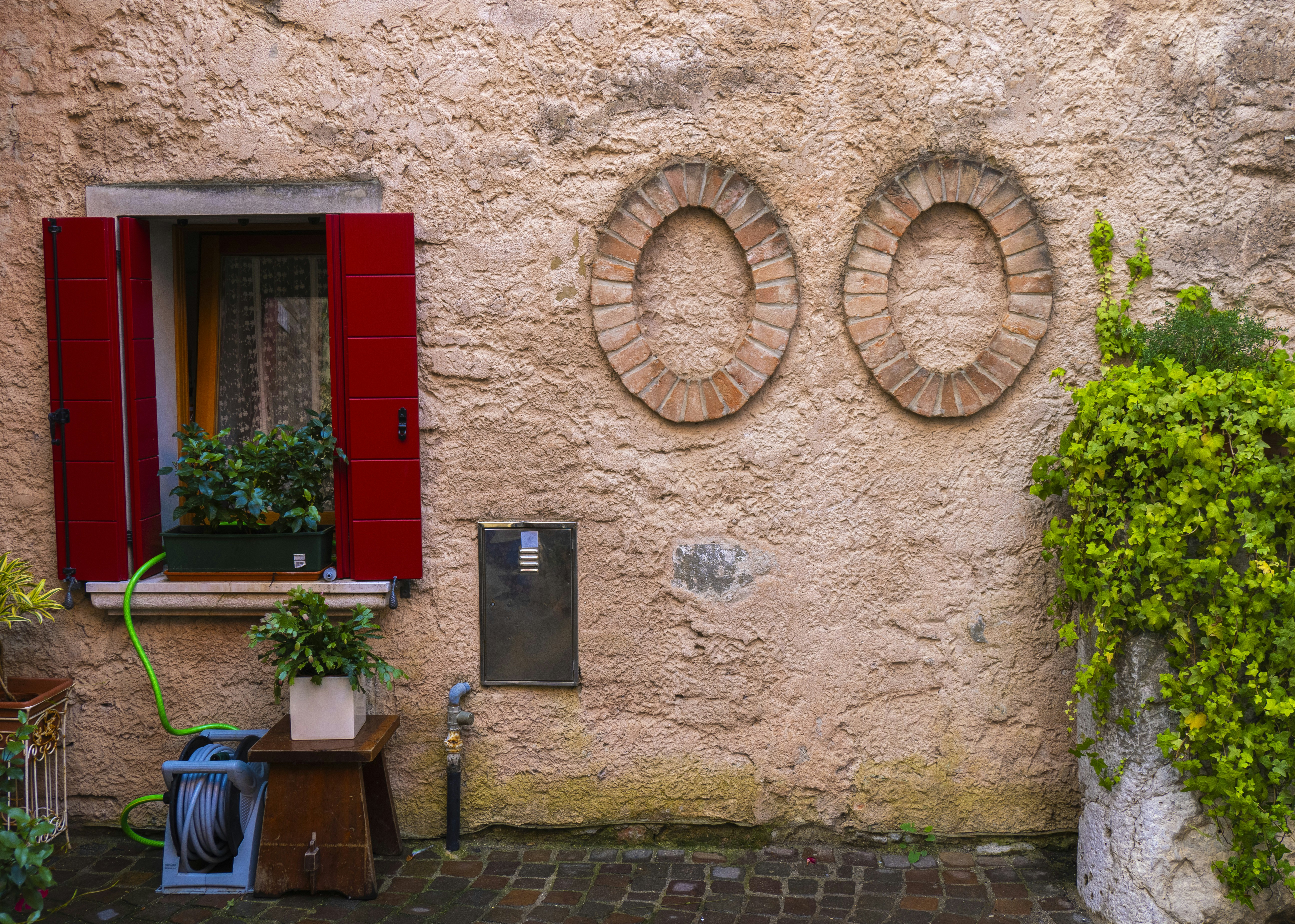 A building with red shutters and a red window photo – Free Plant Image ...
