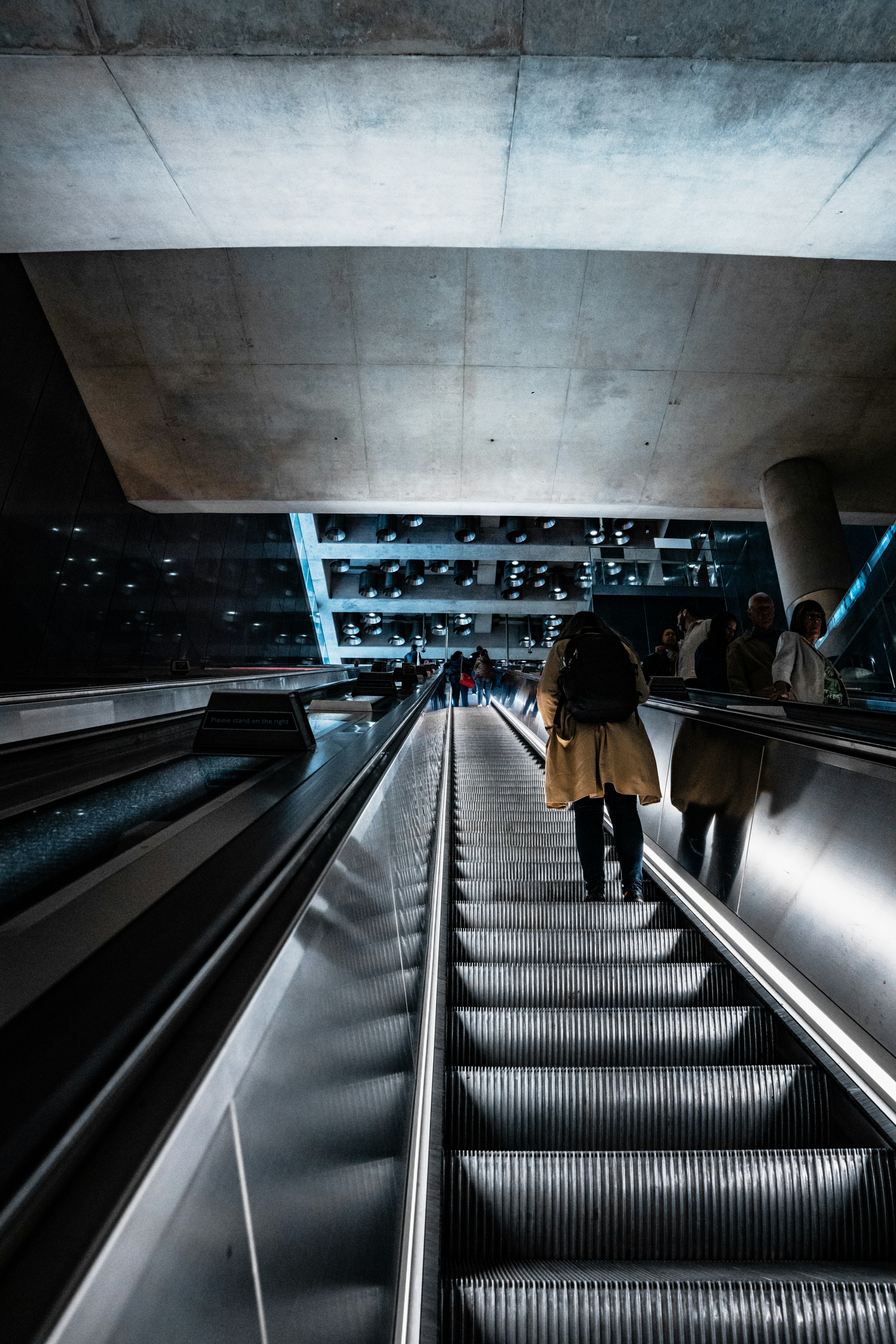 A group of people riding down an escalator photo – Free Uk Image on ...