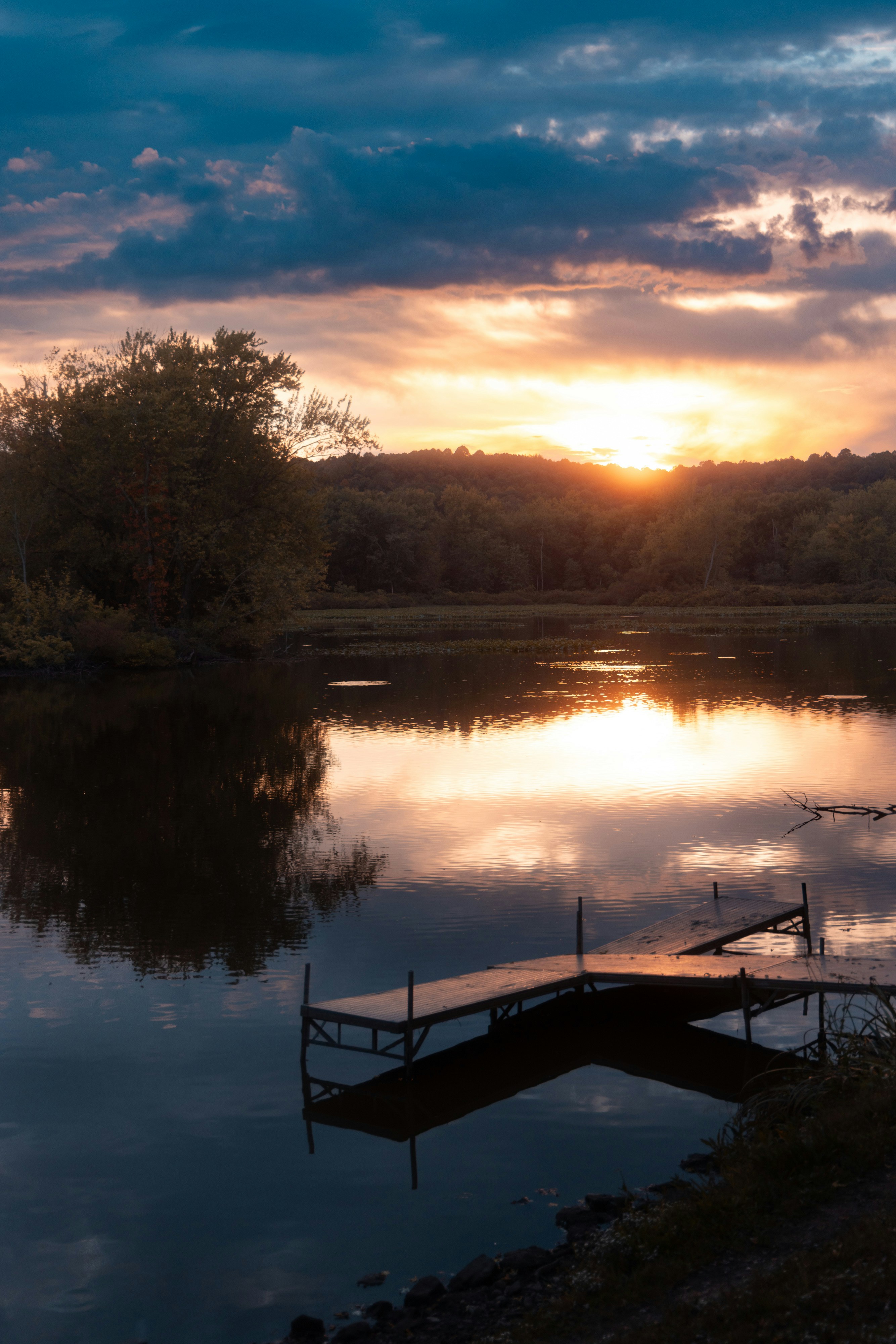 Dusk at the Quiet Dock: Sunset Reflections on a Serene Lake