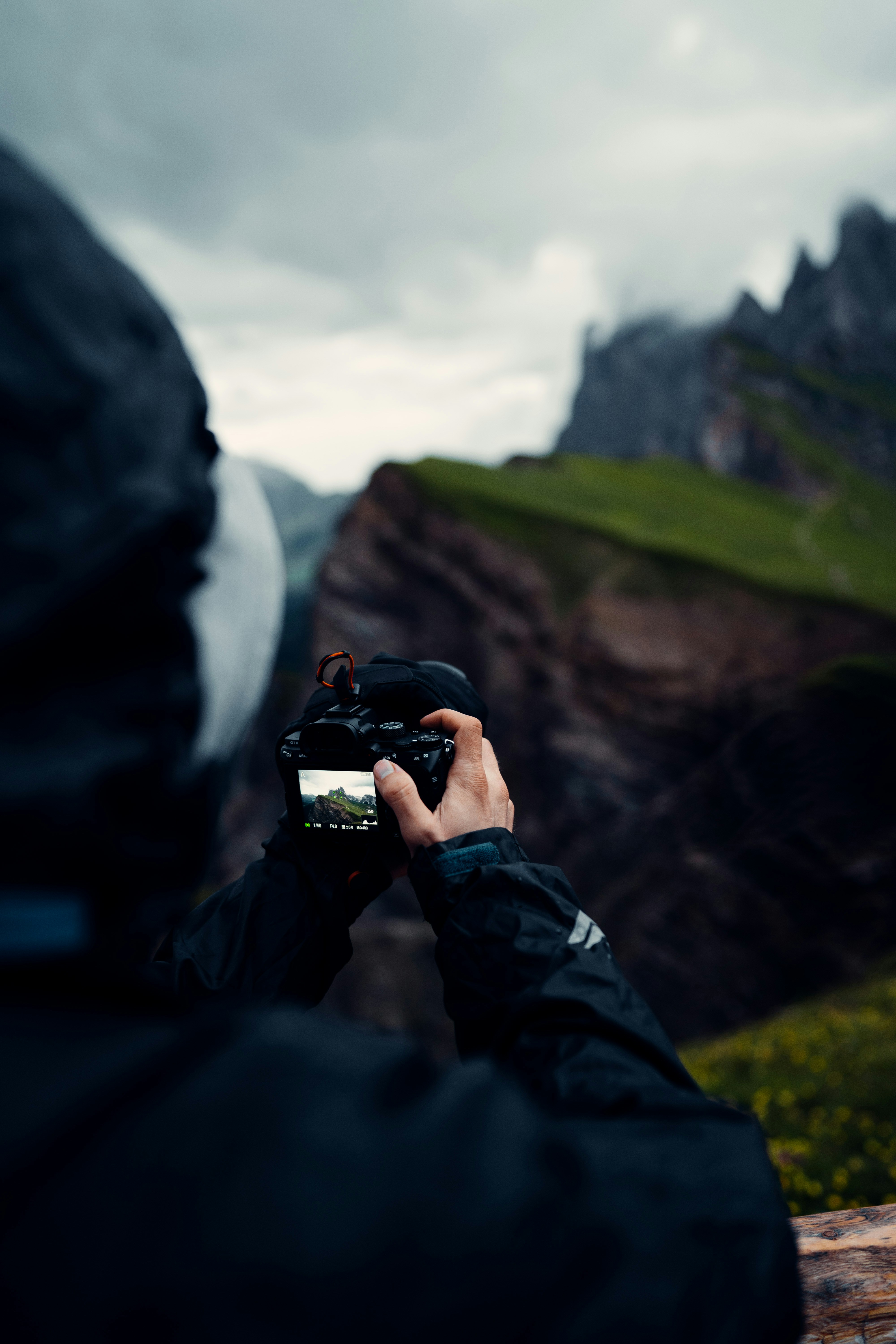 A person taking a picture of a mountain photo – Free Photography Image ...