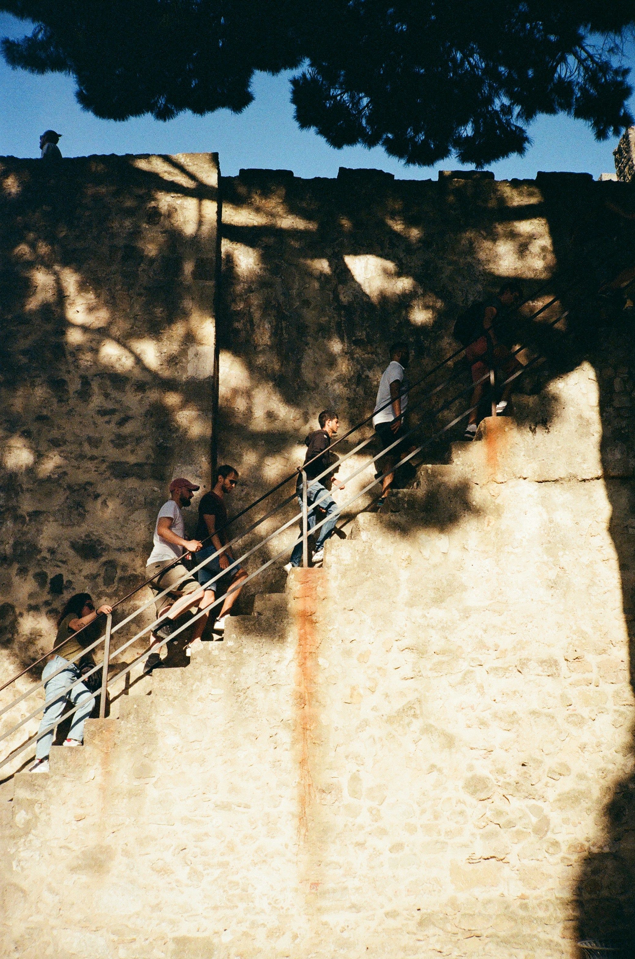 A group of people climbing up a set of stairs photo – Free Handrail ...