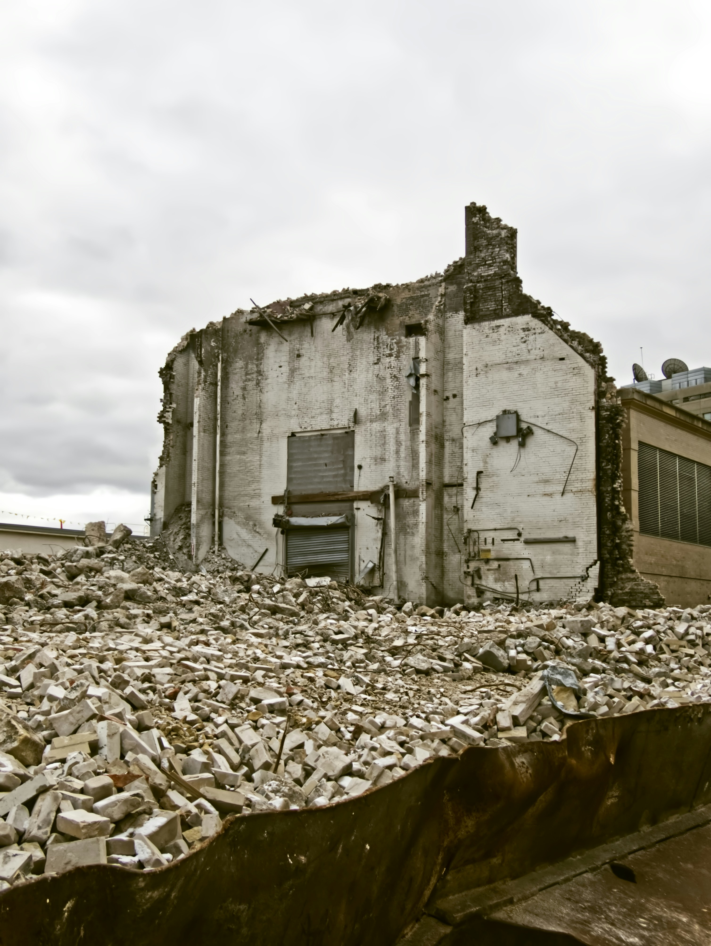 An old building with a bunch of rubble in front of it photo – Free ...