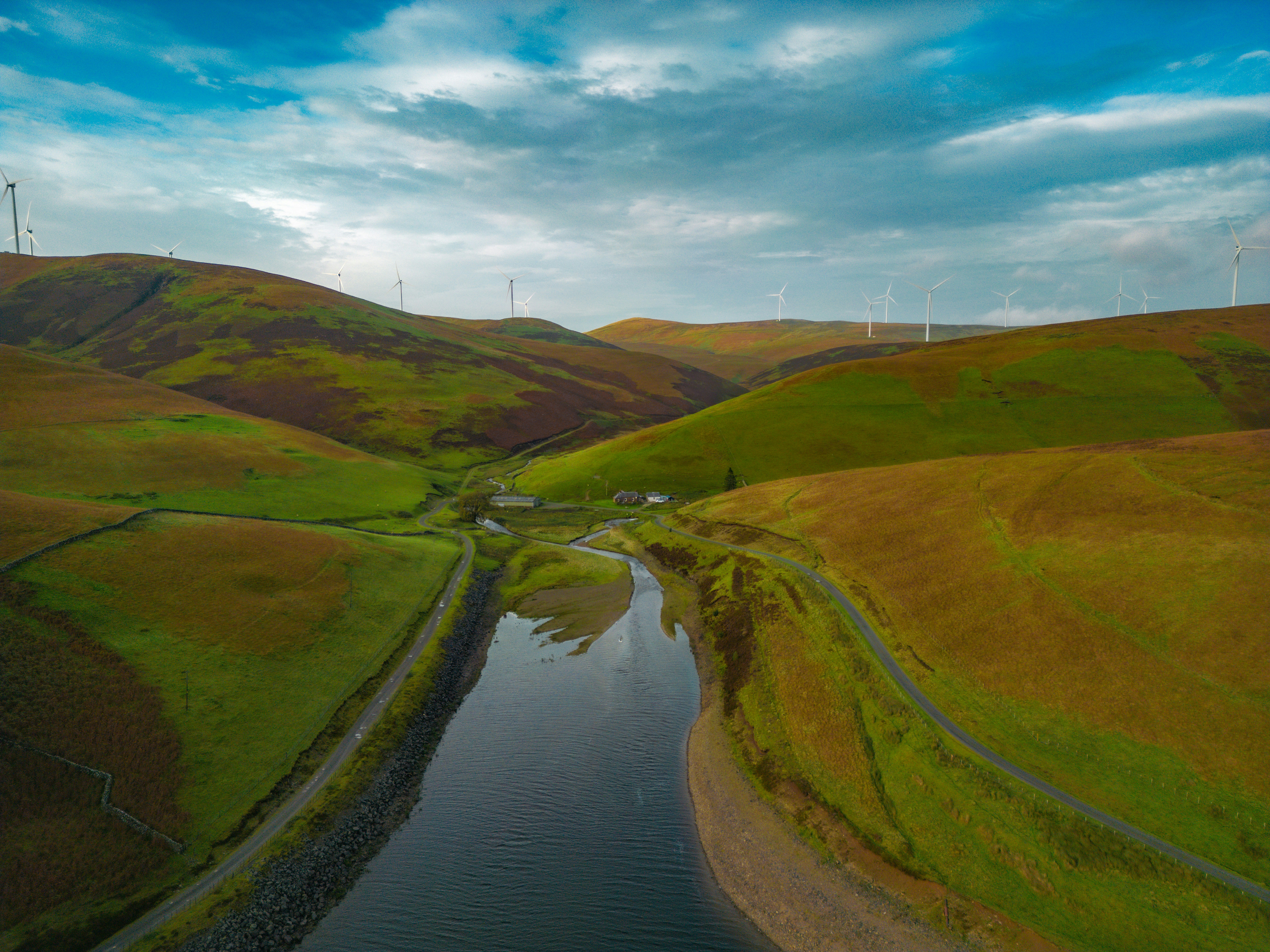 A river running through a lush green hillside photo – Free Biggar Image on Unsplash