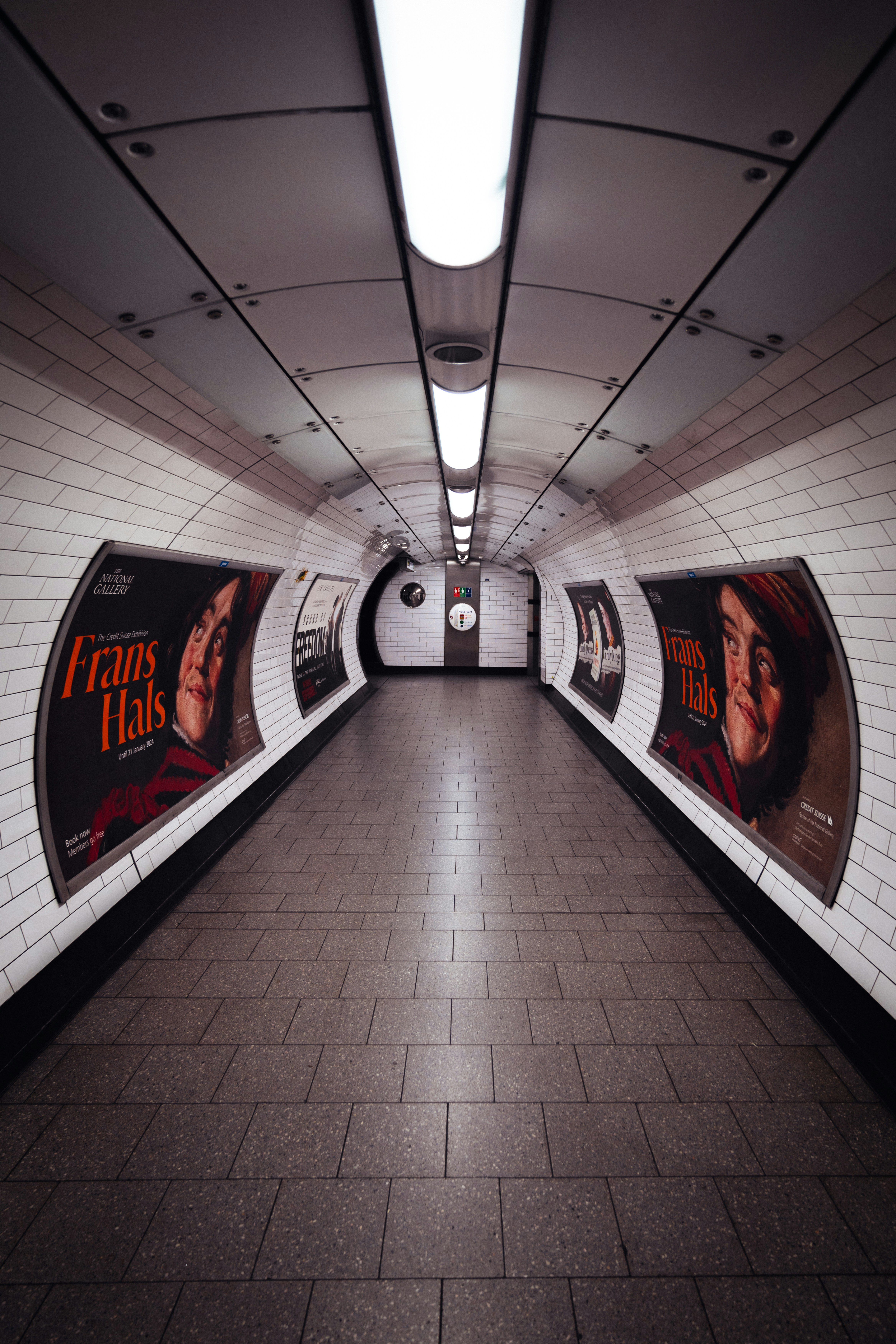 A subway station with posters on the walls photo – Free Uk Image on ...