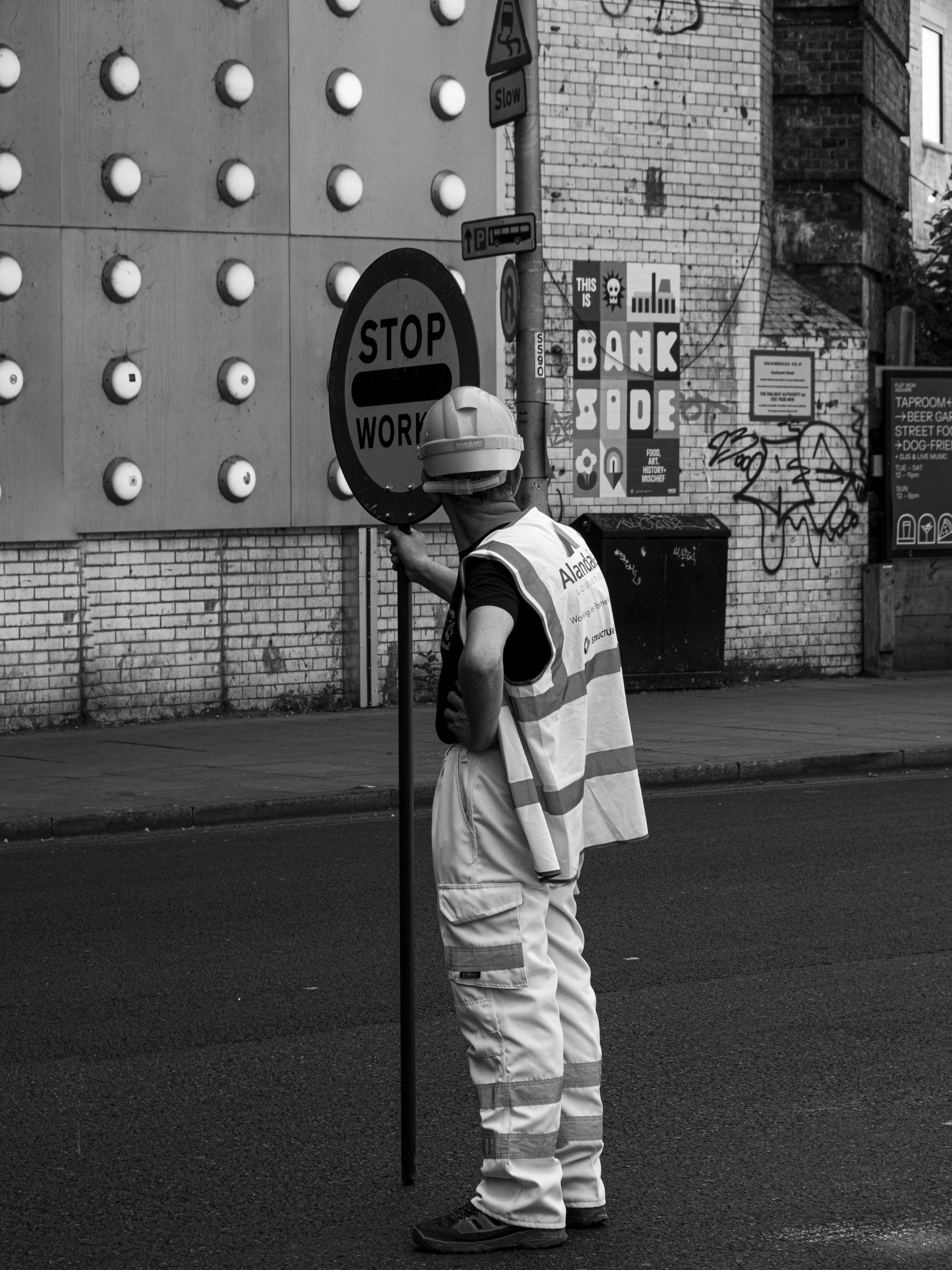 A man standing next to a stop sign photo – Free Uk Image on Unsplash