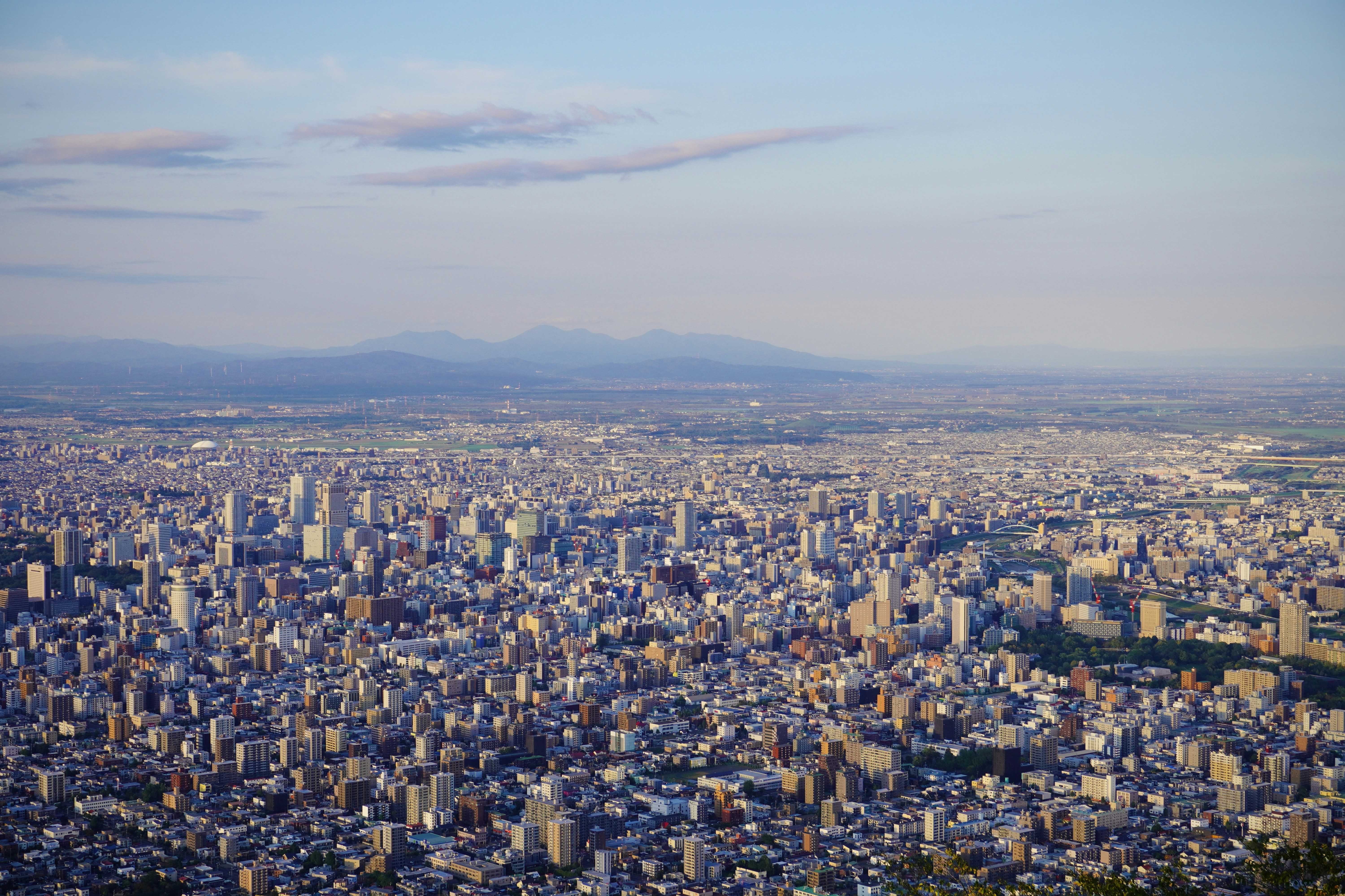 A view of a large city with mountains in the background photo – Free ...