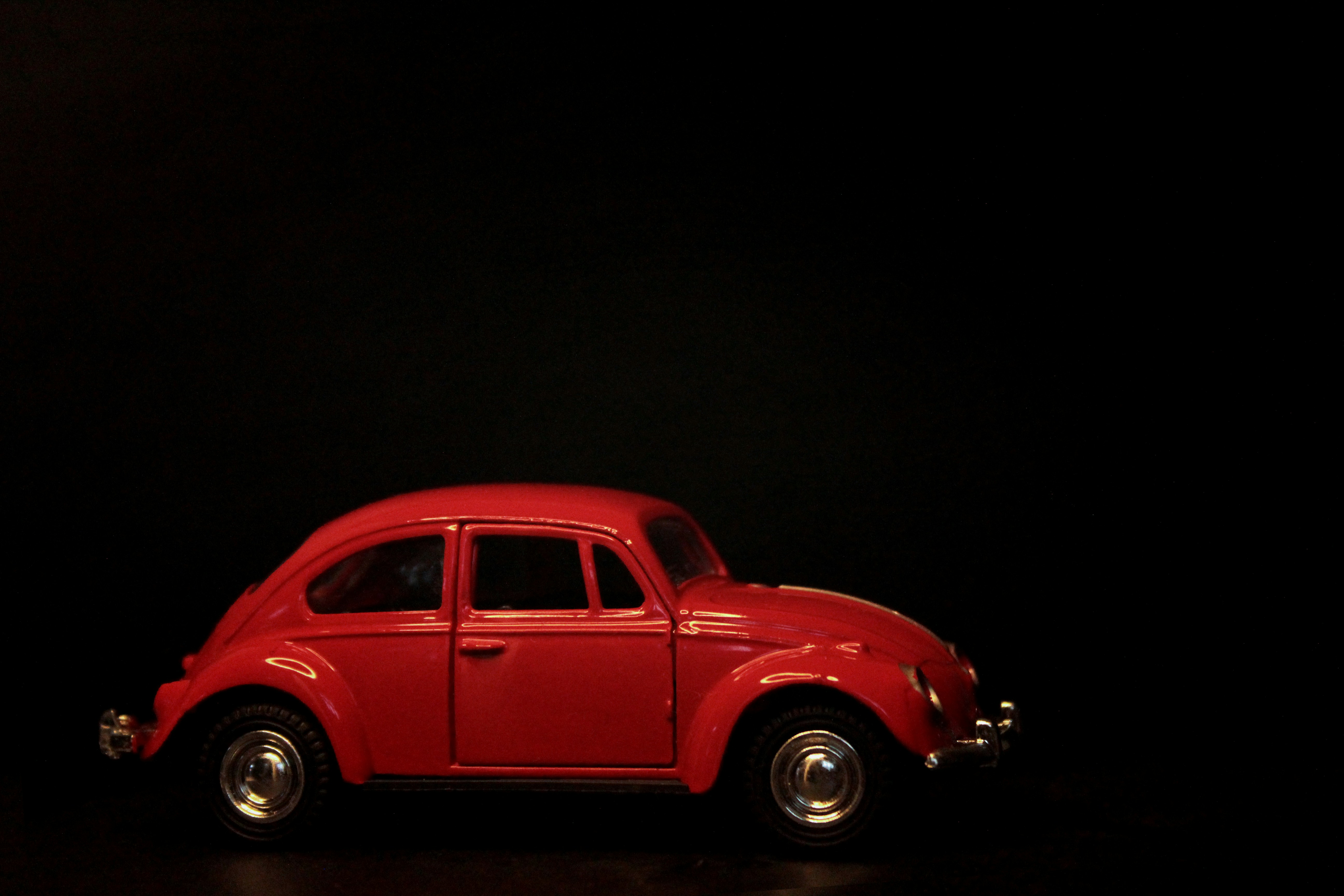 A red toy car on a black background photo – Free Car Image on Unsplash